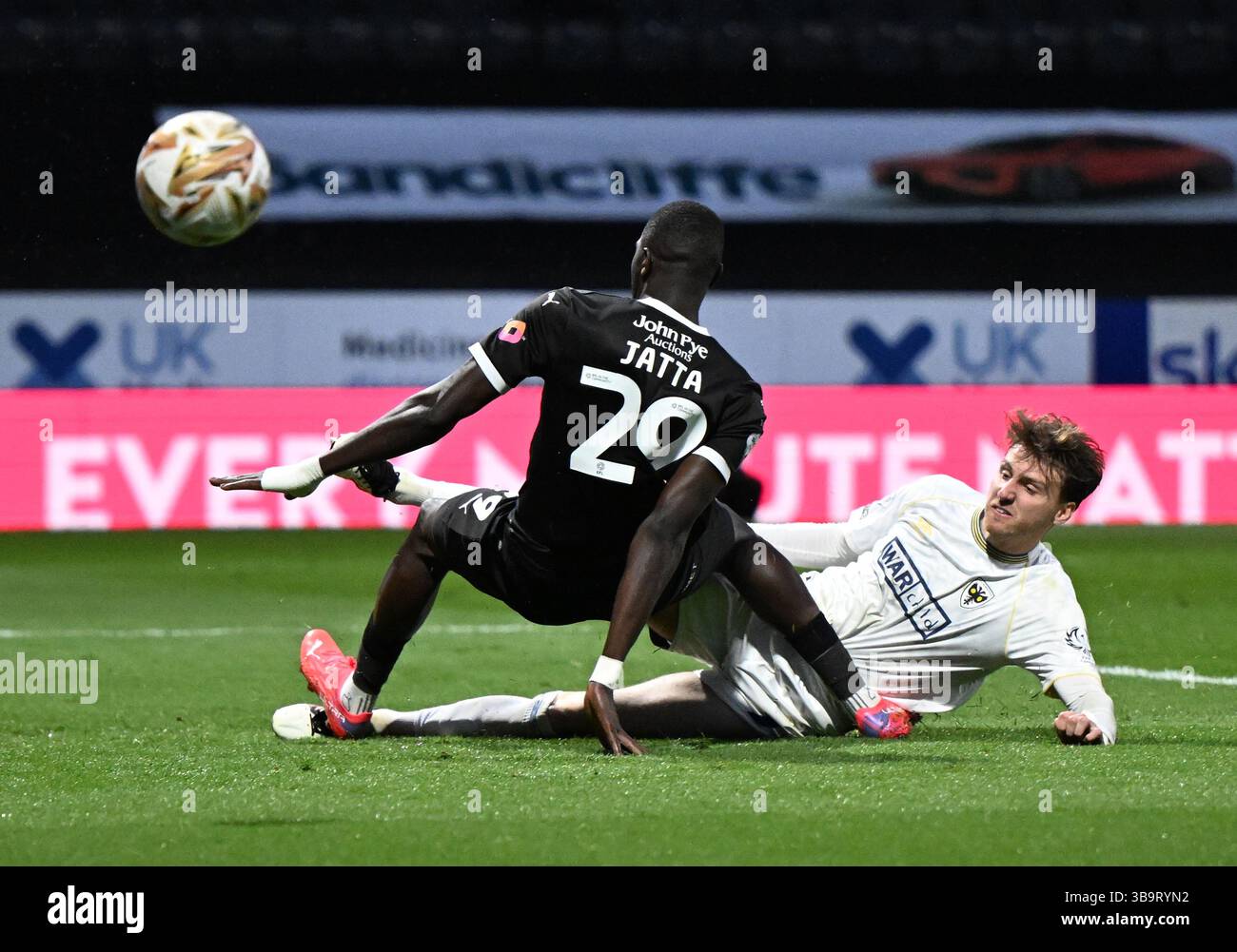 AFC Wimbledon's Riley Harbottle (right) tackles Notts County's Alassana ...