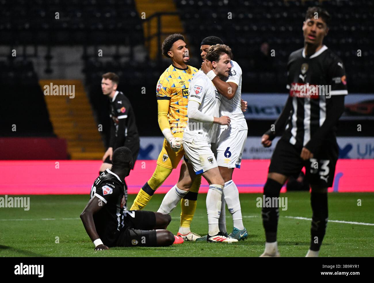 AFC Wimbledon's Riley Harbottle (centre) is congratulated for tackling ...