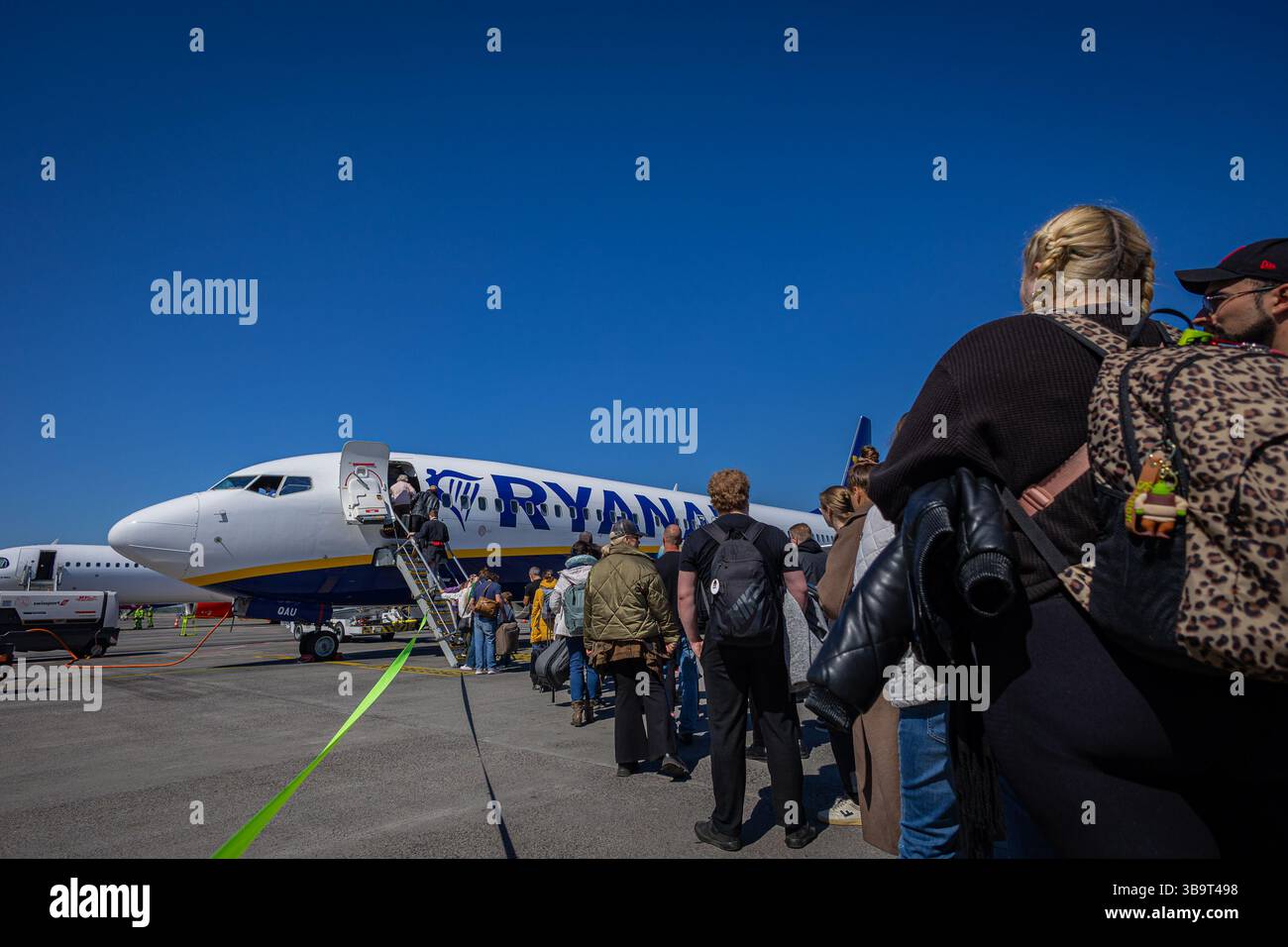 Berlin, Germany, 28.4.2025: Passengers board a Ryanair plane via a ...