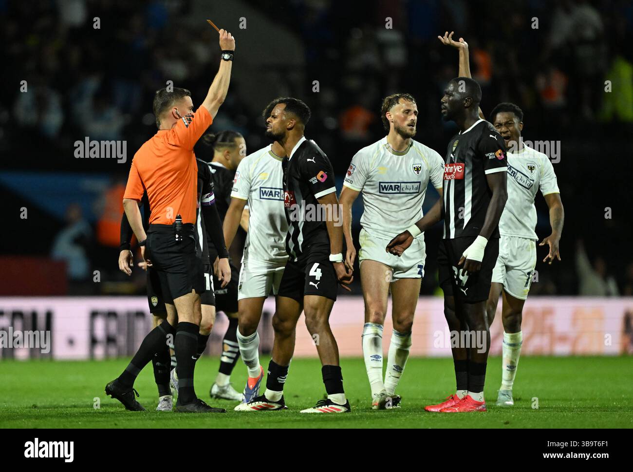 Notts County's Alassana Jatta (second right) is shown a red card by ...