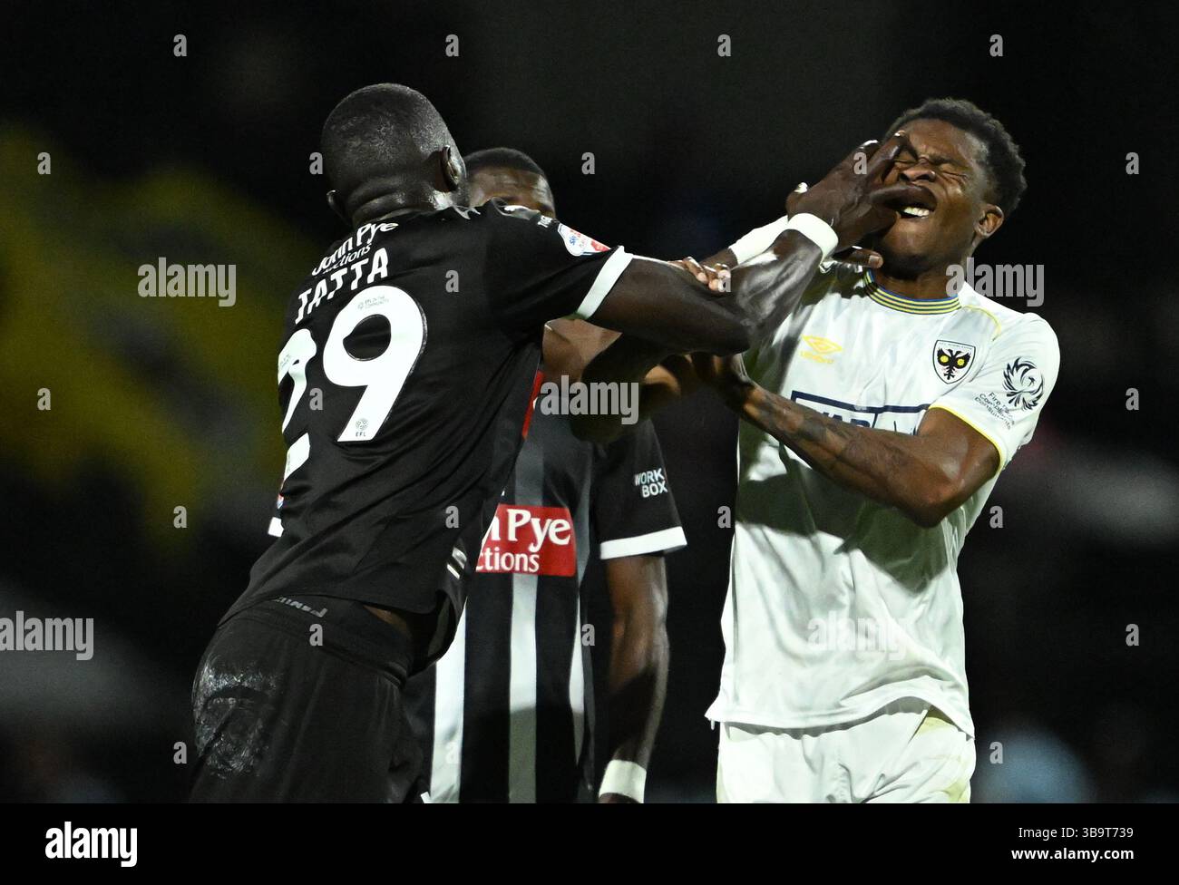 Notts County's Alassana Jatta (left) reacts to AFC Wimbledon's Josh ...
