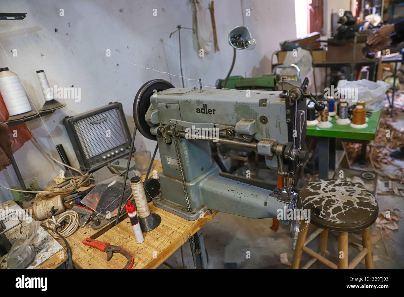 Sewing machine in the factory of boots, saddlery, footwear and leather ...