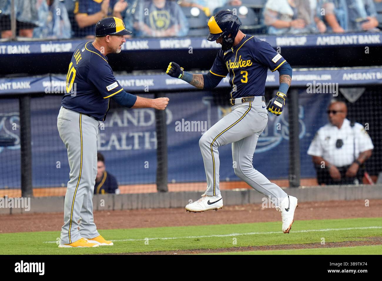Milwaukee Brewers' Joey Ortiz (3) celebrates with third base coach ...
