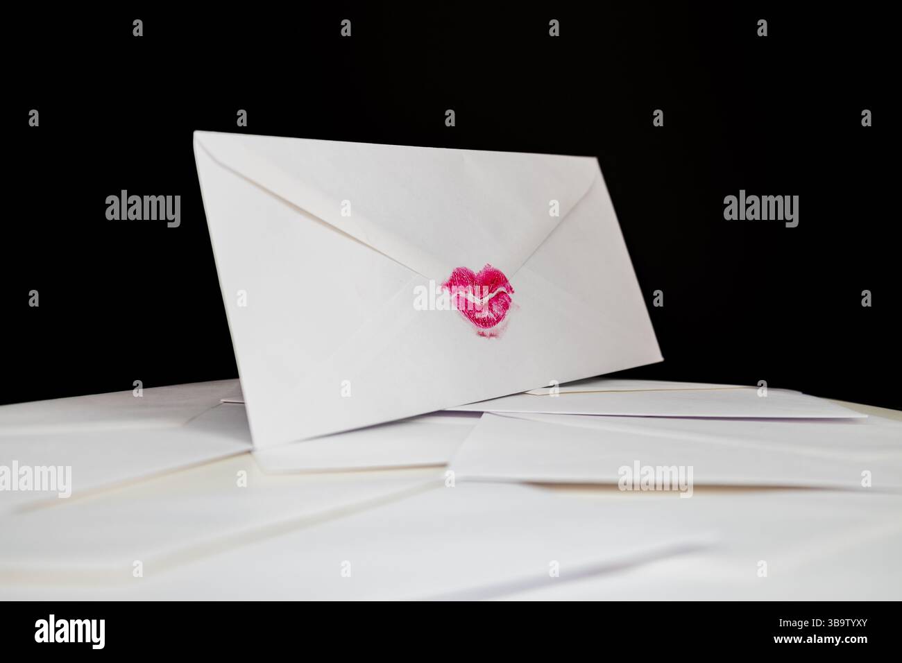 Letter sealed by a kiss surrounded by a lot of letters Stock Photo - Alamy