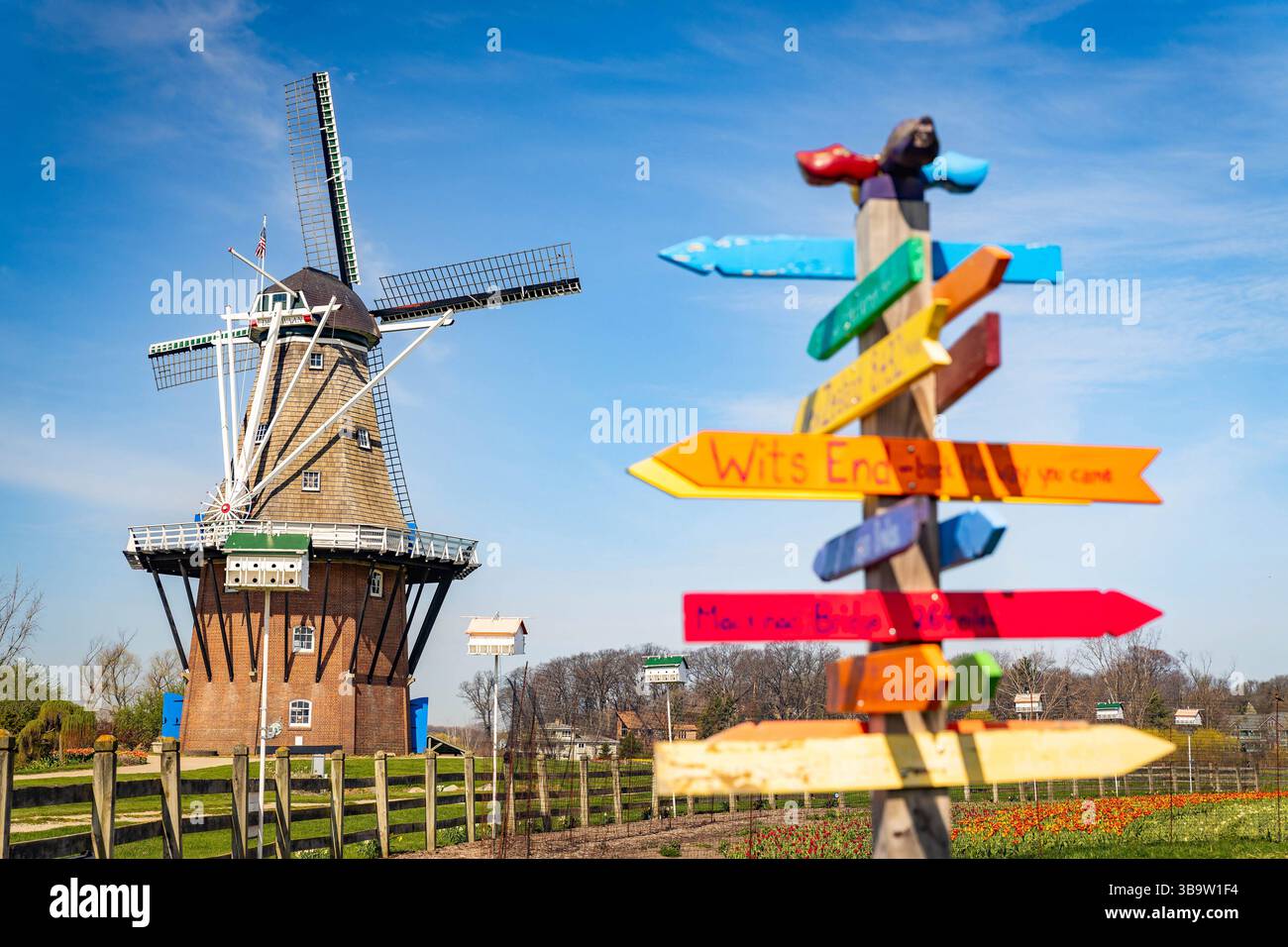 Photo of real Dutch windmill next to colorful country directions sign ...