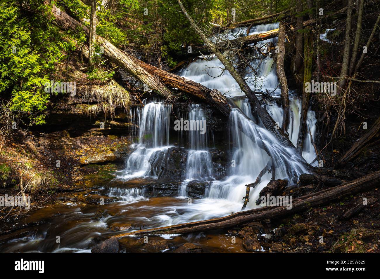 Photo of Wagner Falls flowing through forest at Pictured Rocks National ...