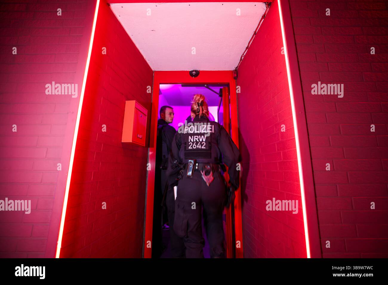 Duisburg, Germany. 10th May, 2025. A police officer enters a brothel in ...
