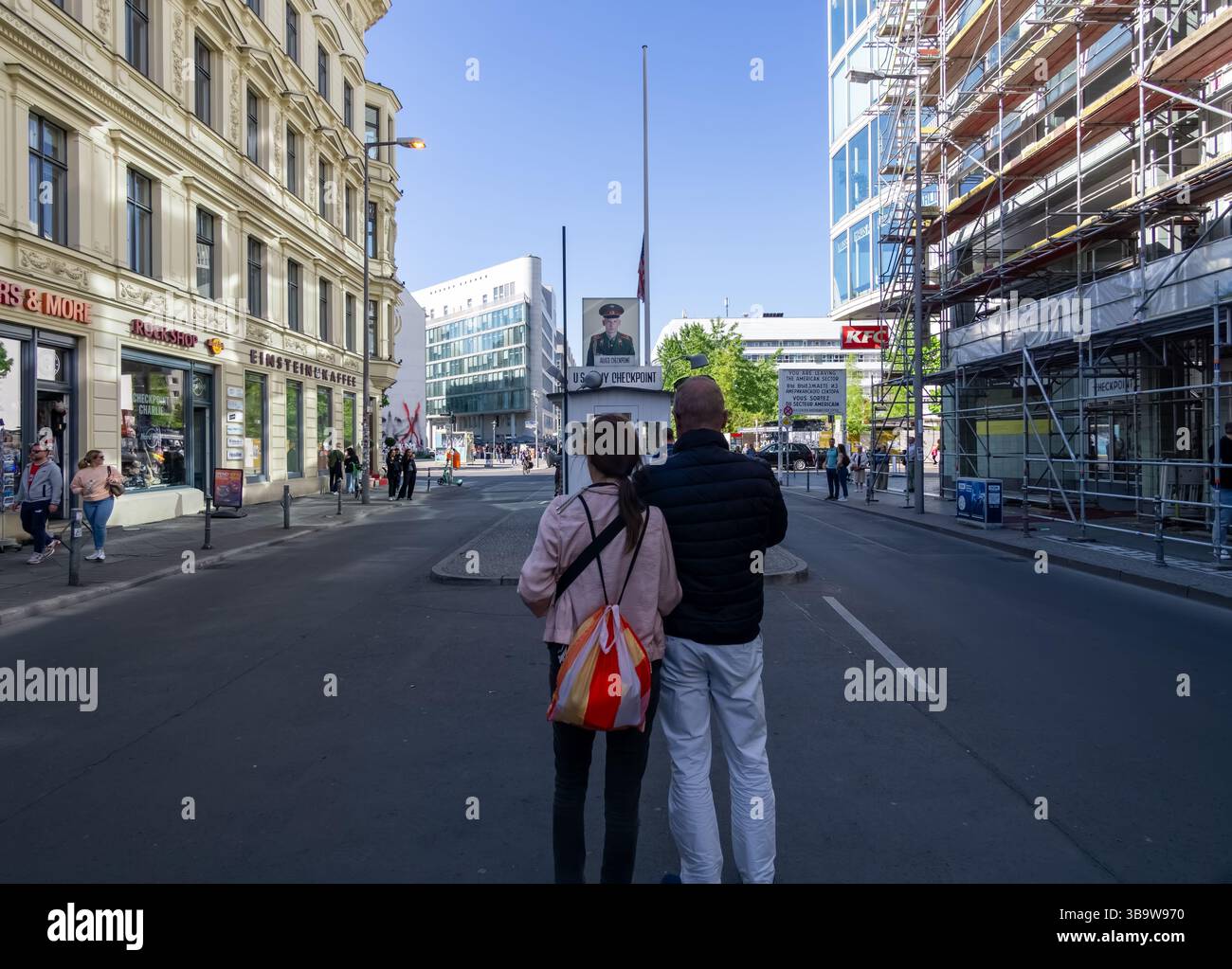 Two tourists stand at the historic Checkpoint Charlie border crossing ...