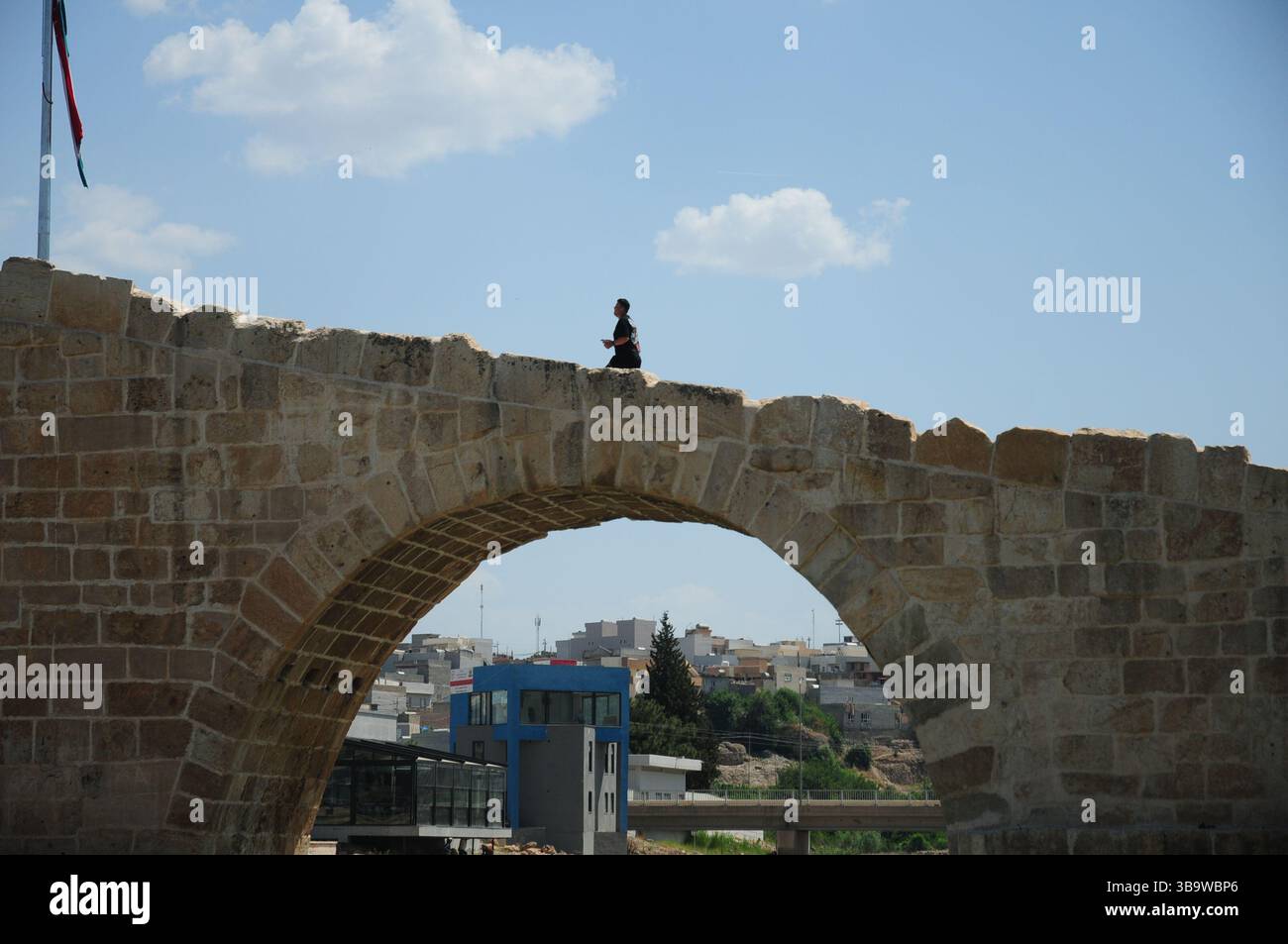 Dohuk, Iraq. 10th May, 2025. A man walks on the ancient Dalal Bridge in ...