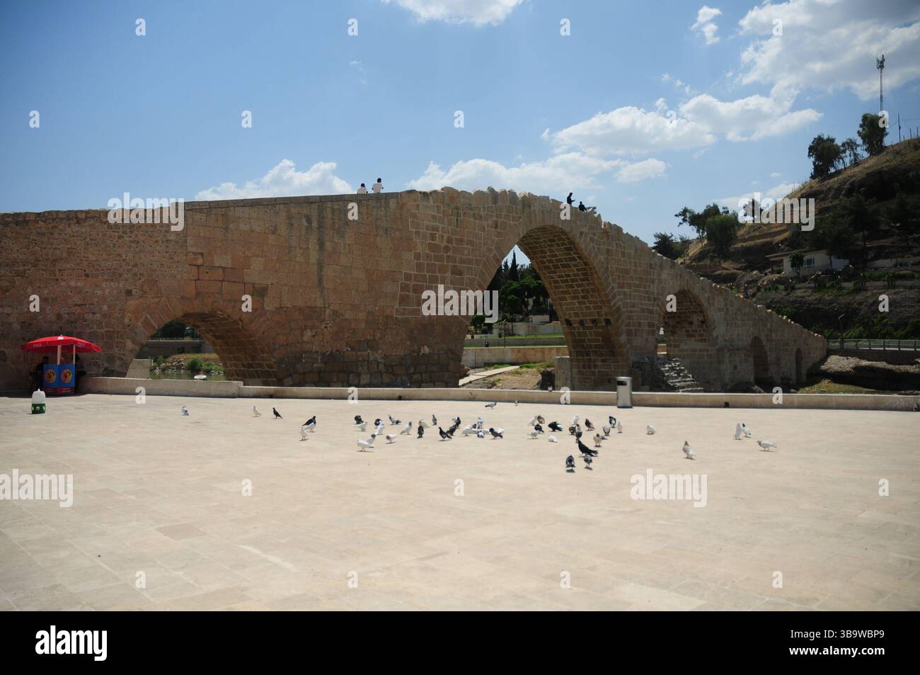 Dohuk, Iraq. 10th May, 2025. People walk on the ancient Dalal Bridge in ...