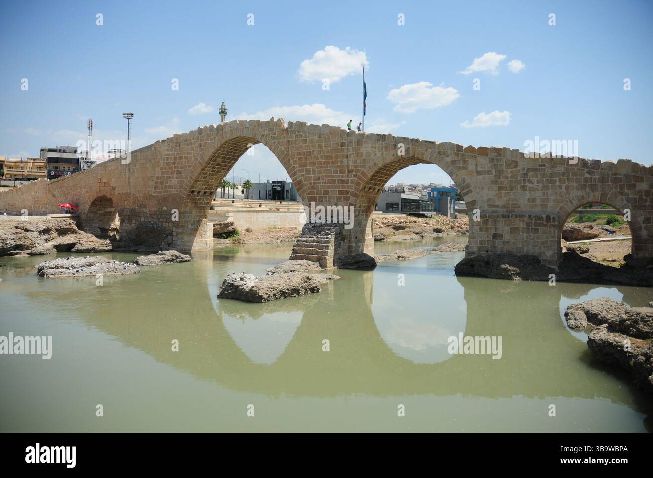 Dohuk, Iraq. 10th May, 2025. People walk on the ancient Dalal Bridge in ...