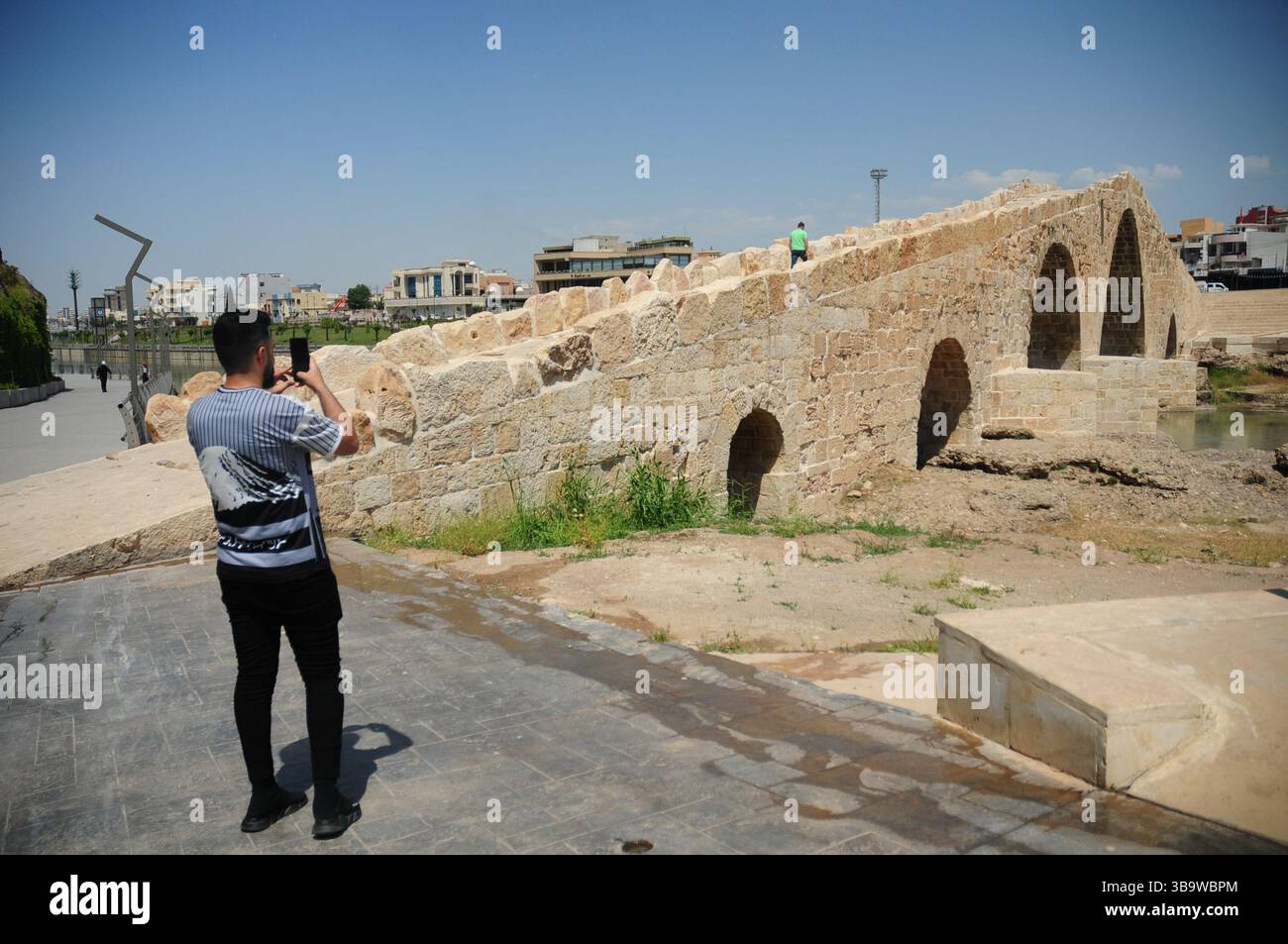 Dohuk, Iraq. 10th May, 2025. A man takes photos of the ancient Dalal ...