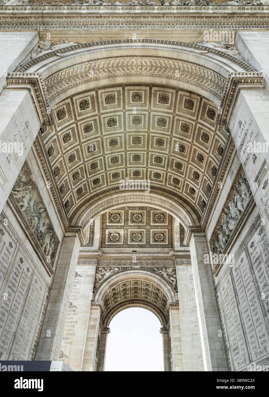 France, Paris - May 03, 2025 - The majestic details of ornate stone carvings under the arch of ...