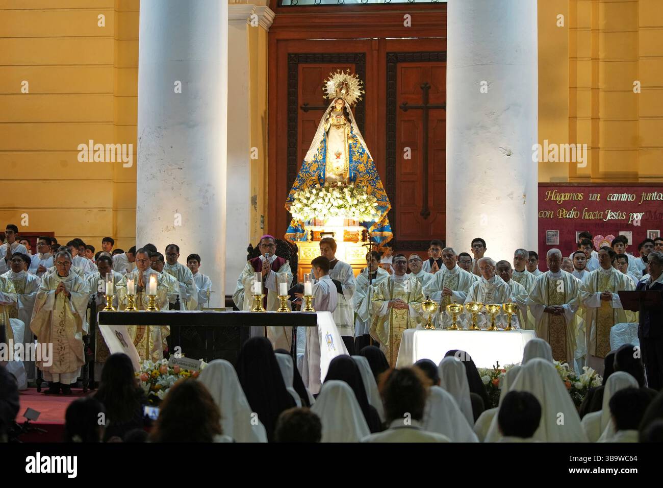 Parishioners attend an outdoor Mass in honor of newly-elected Pope Leo ...