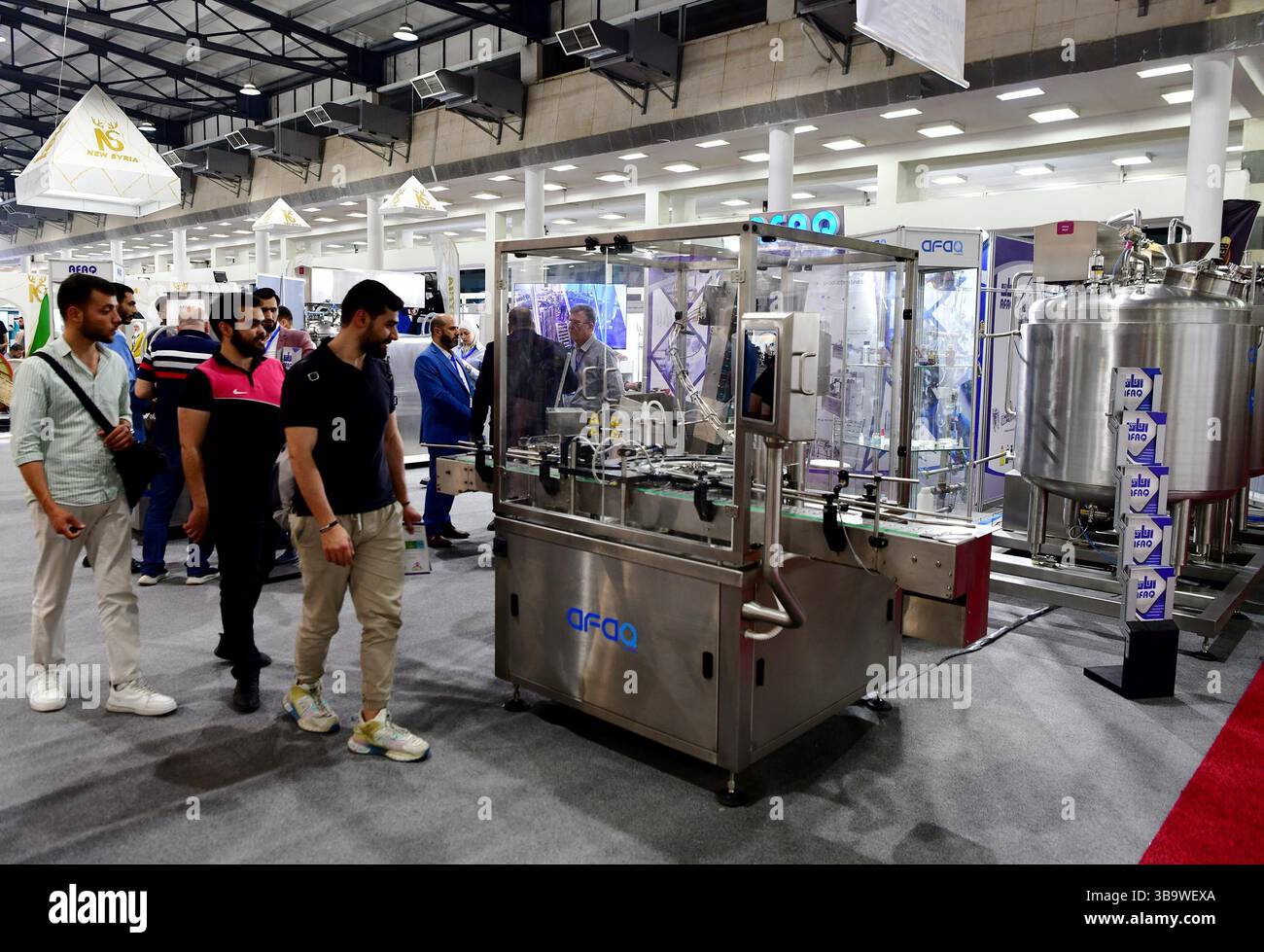 Damascus, Syria. 10th May, 2025. Attendees observe a machine on display at the Techno Build ...