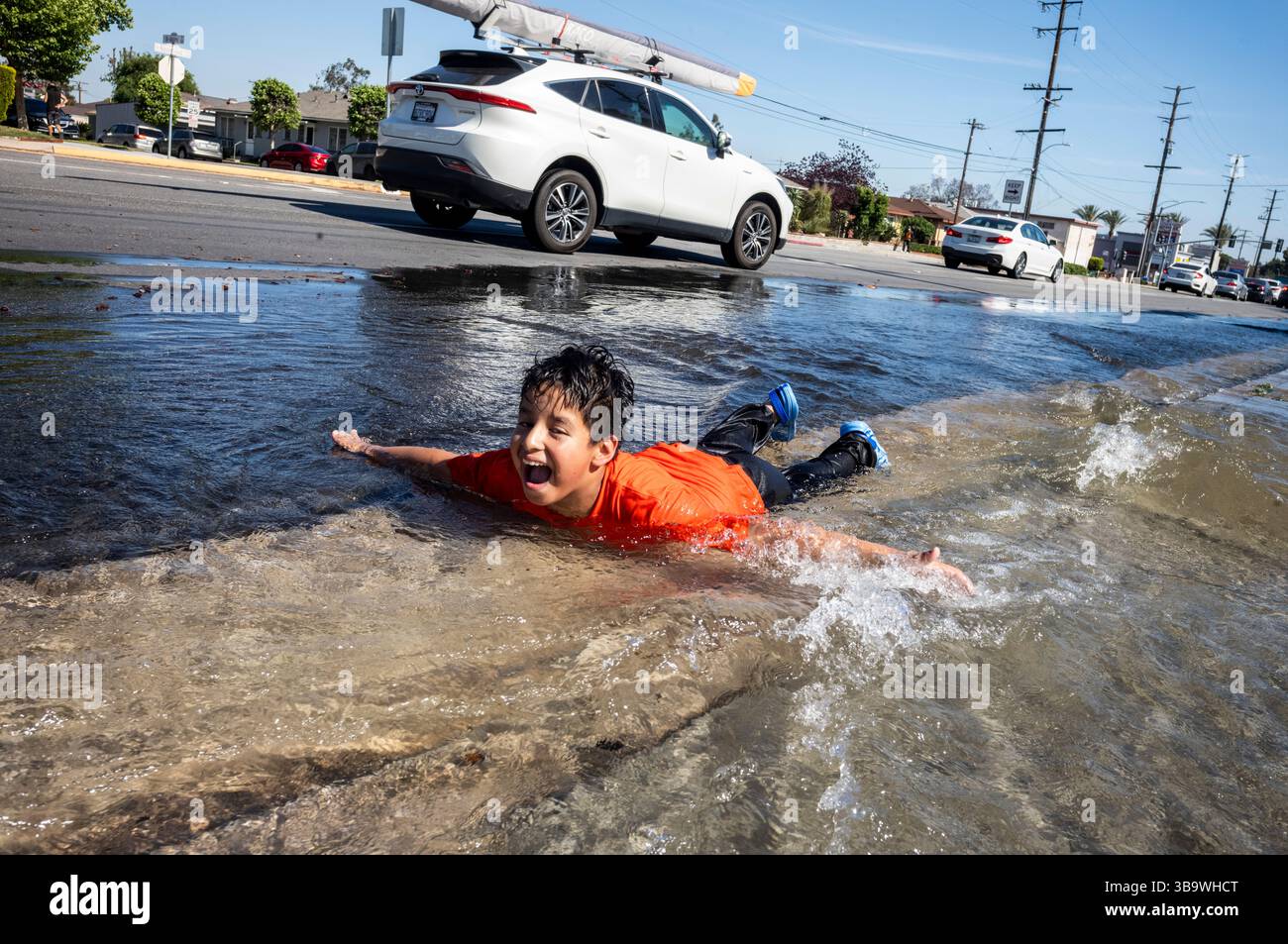 Los Angeles, United States. 10th May, 2025. A boy plays in water from a ...