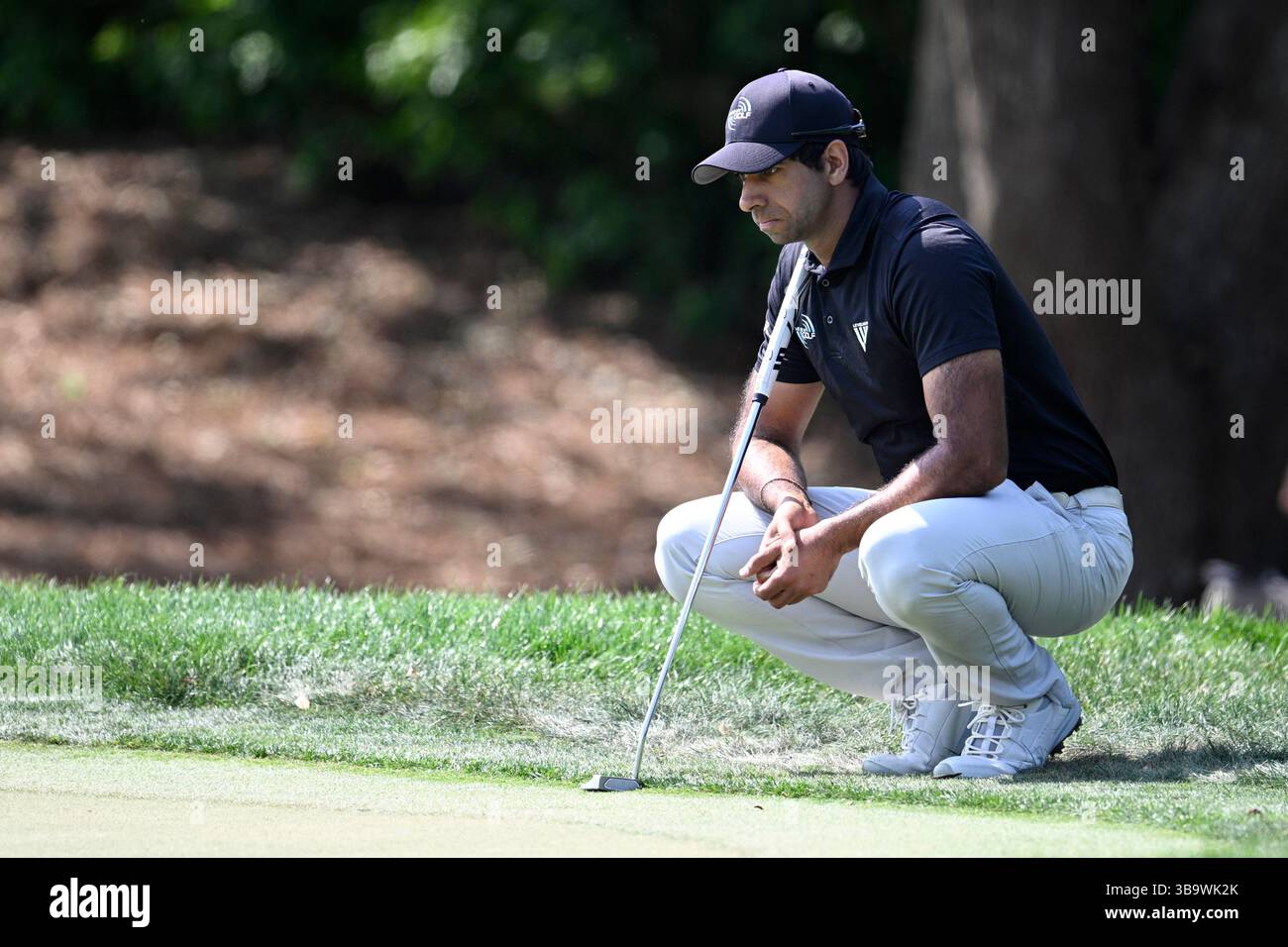 Aaron Rai, of England, lines up his putt on the first green during the ...
