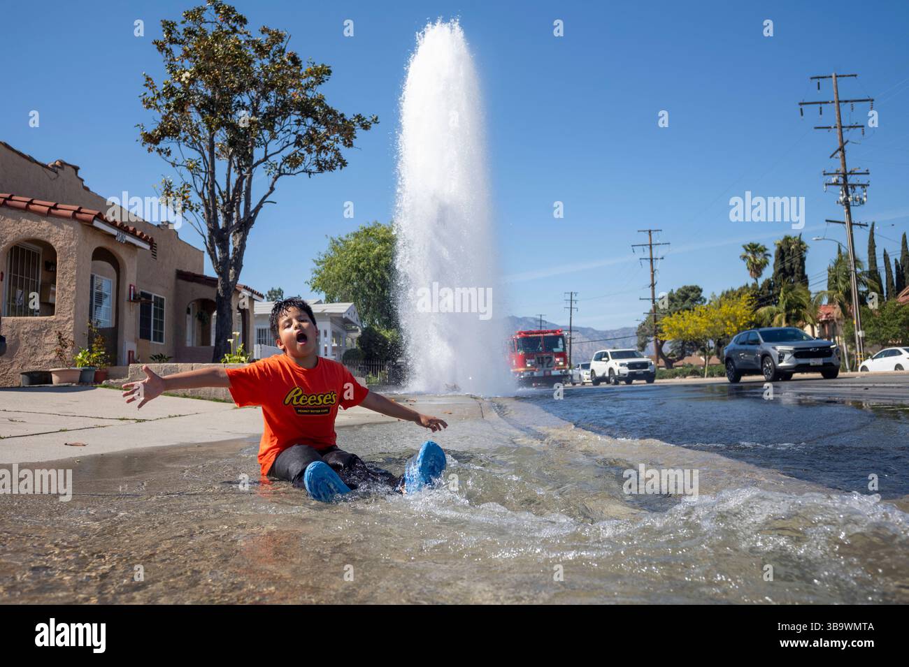 Los Angeles, California, USA. 10th May, 2025. A boy plays in water from ...