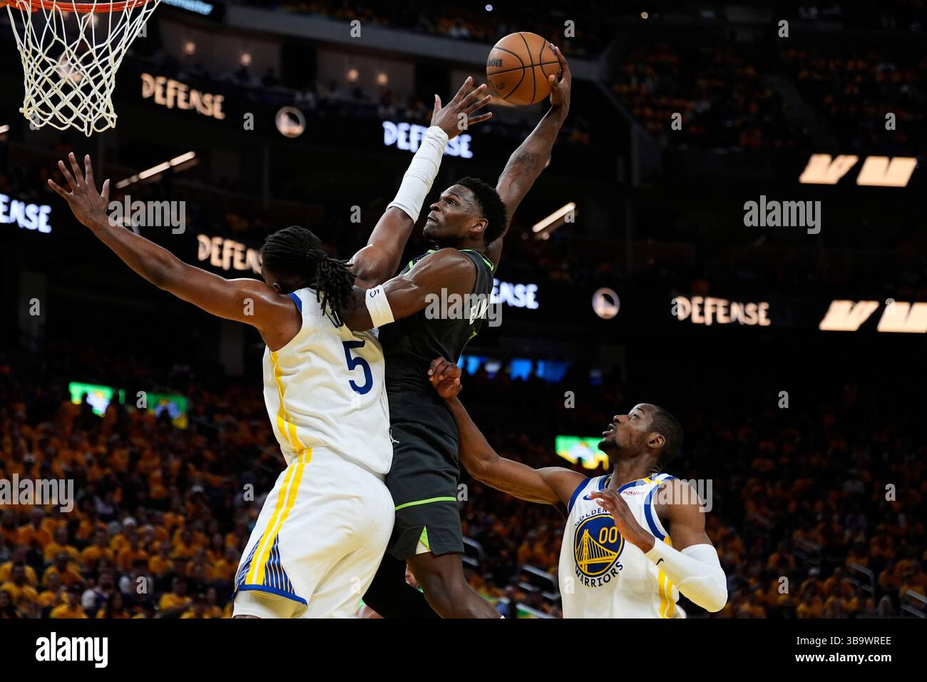 Minnesota Timberwolves guard Anthony Edwards, center, dunks over Golden ...