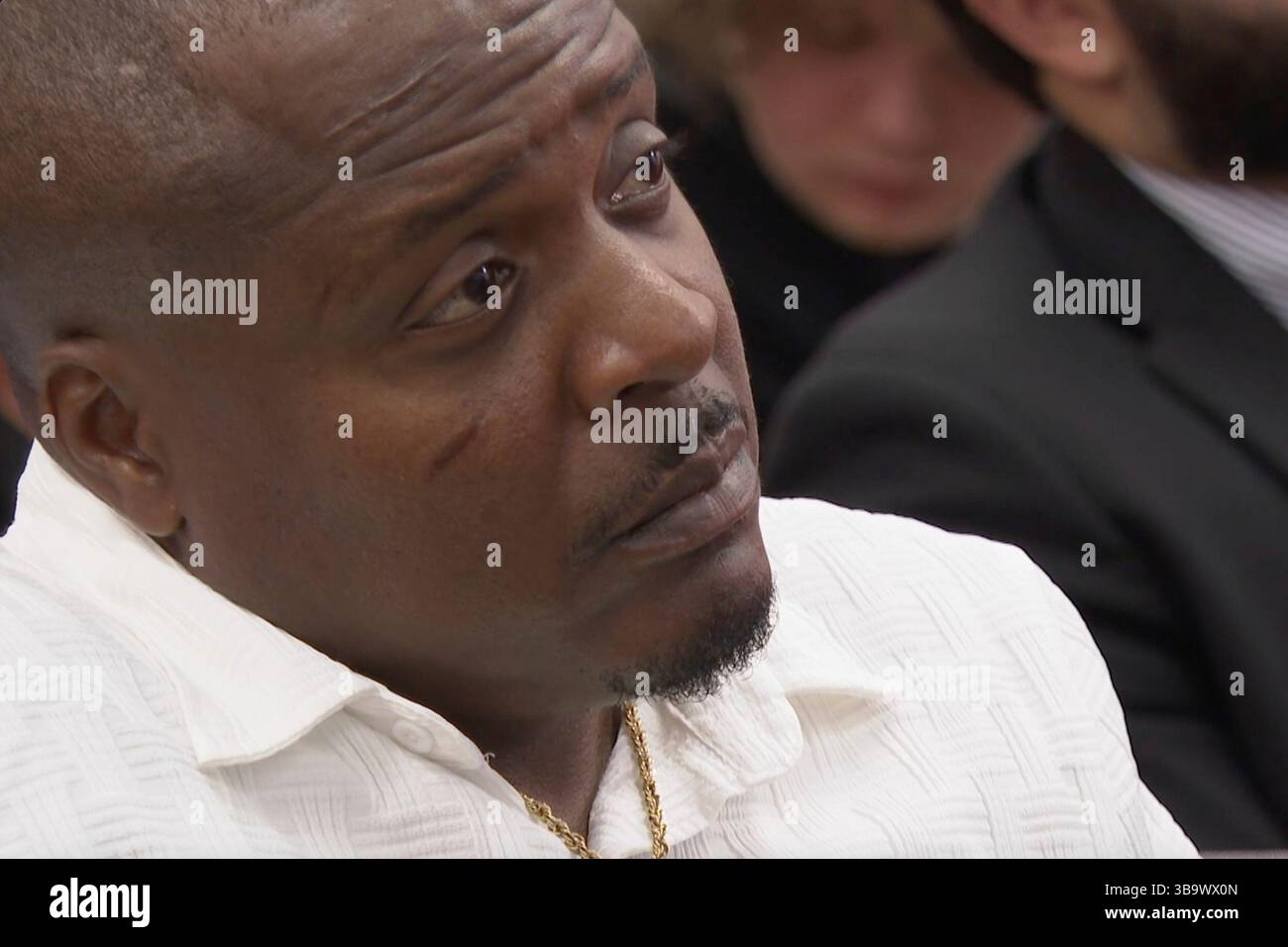 Jermaine Hudson listens as Bobby Gumpright speaks to lawmakers at a ...