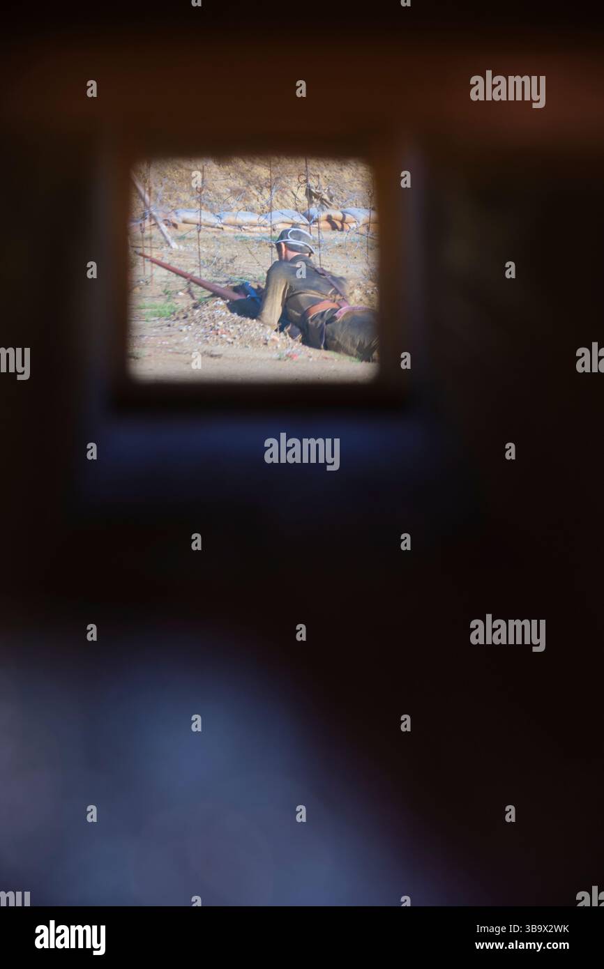 The view through a wood periscope tool, looking at a soldier. At The ...