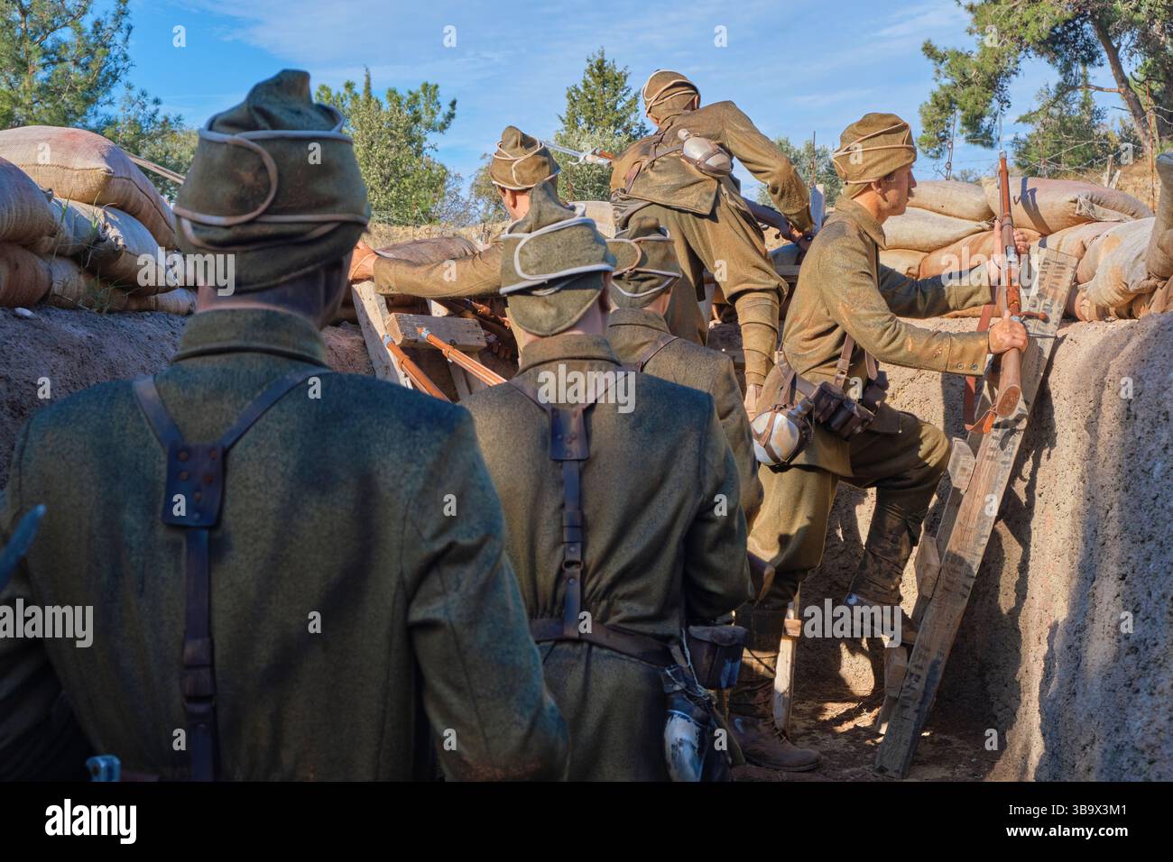 Turkish troops, lined up in formation, preparing to climb a ladder over the trench wall. At The ...