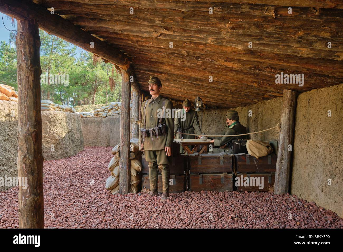 A group of Turkish officers, at a table, examining a war planning map ...