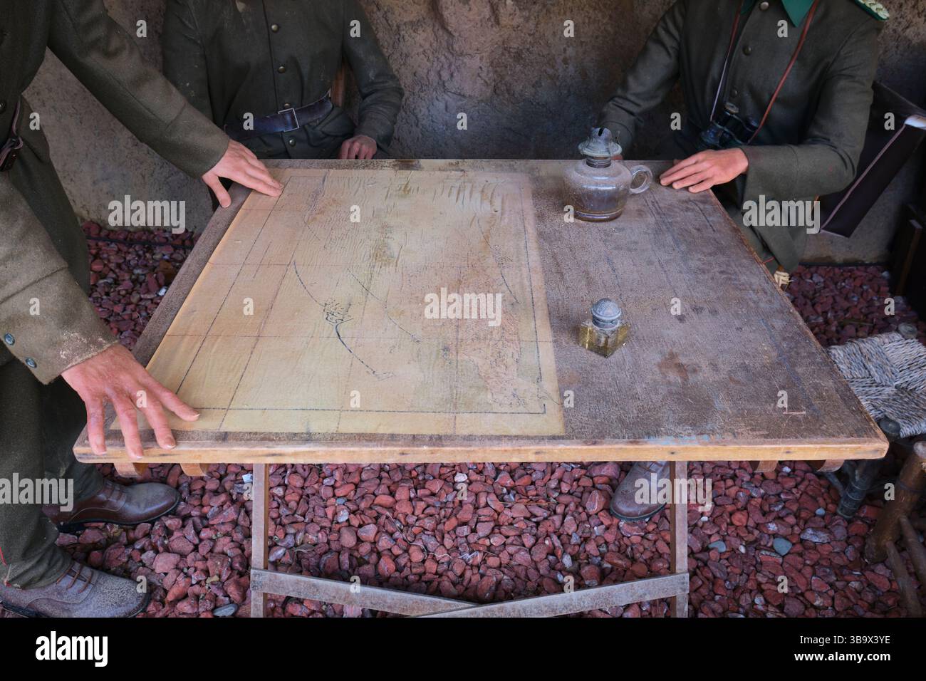 A group of Turkish officers, at a table, examining a war planning map ...