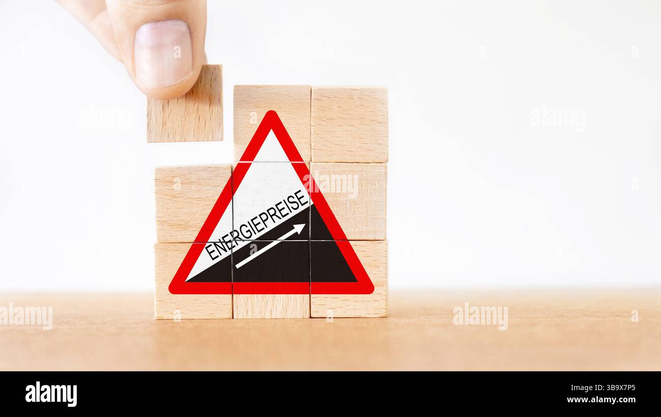 A hand places a wooden block onto a stack, creating a visual metaphor ...