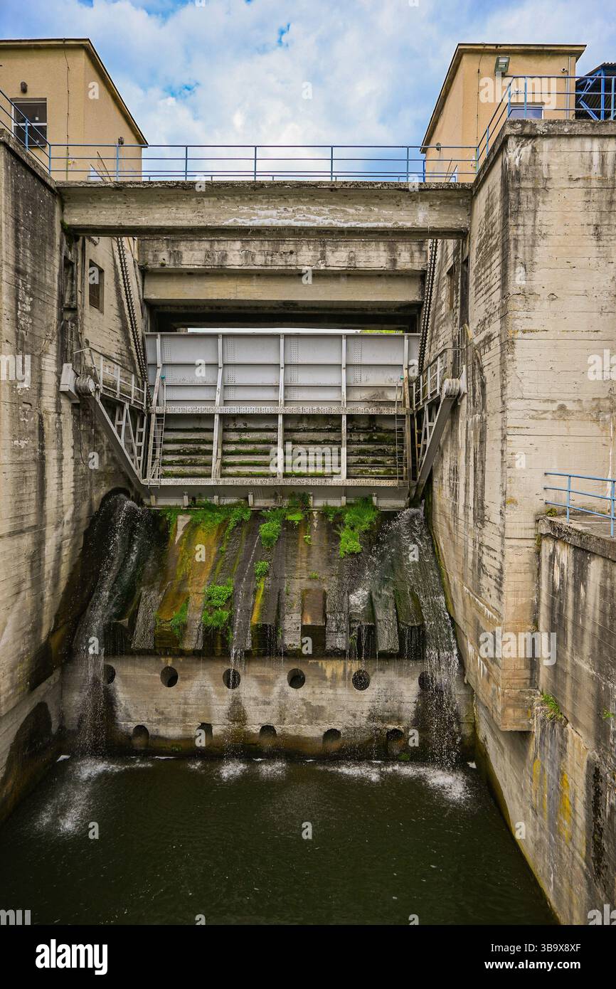 Water flowing through dam infrastructure, creating small waterfalls ...