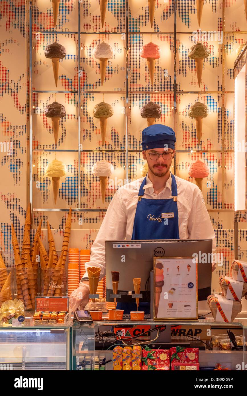 A tall man behind the counter in a Gelato shop or store in Sydney ...