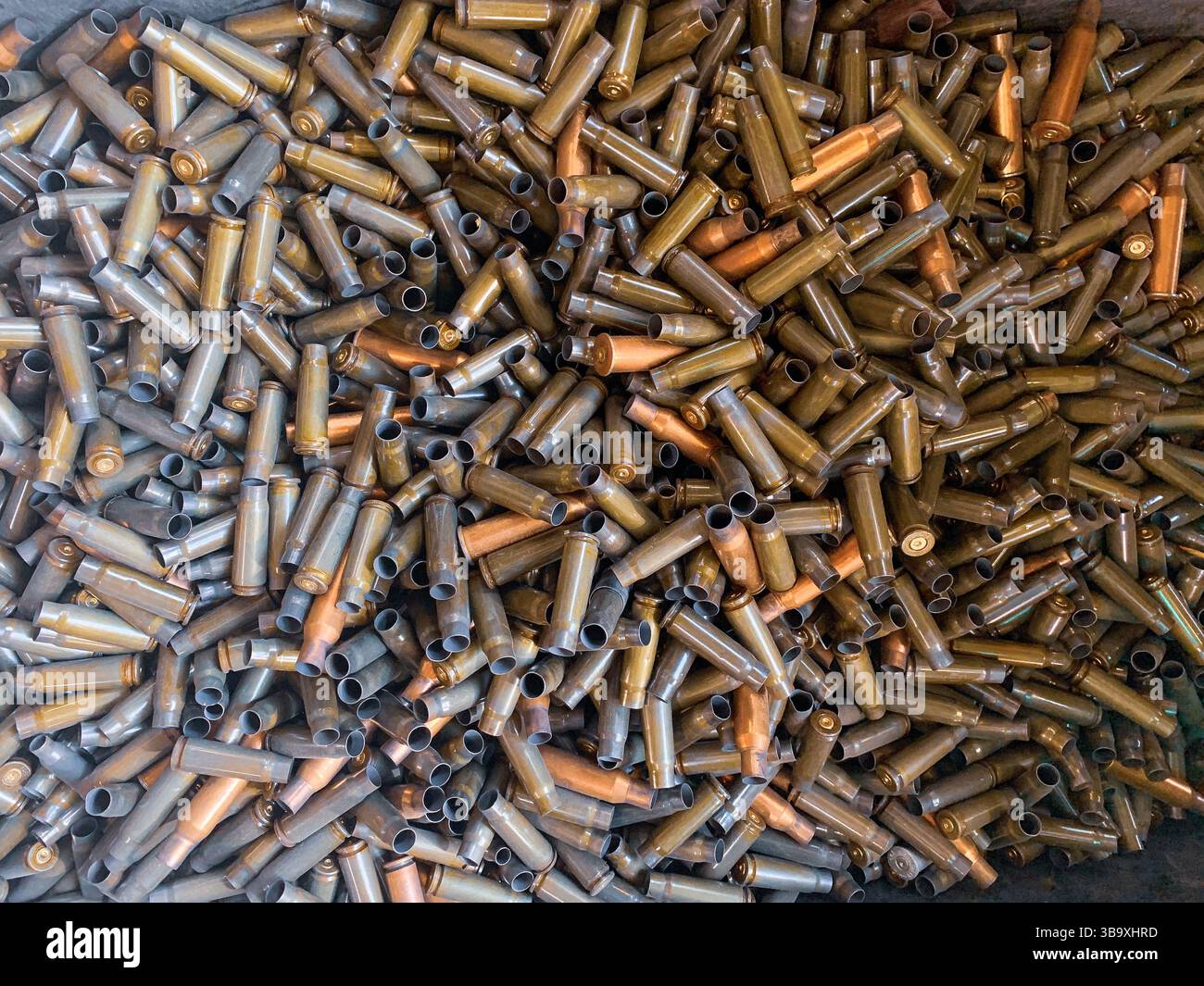 Spent bullet casings scattered on the floor at an indoor shooting range ...