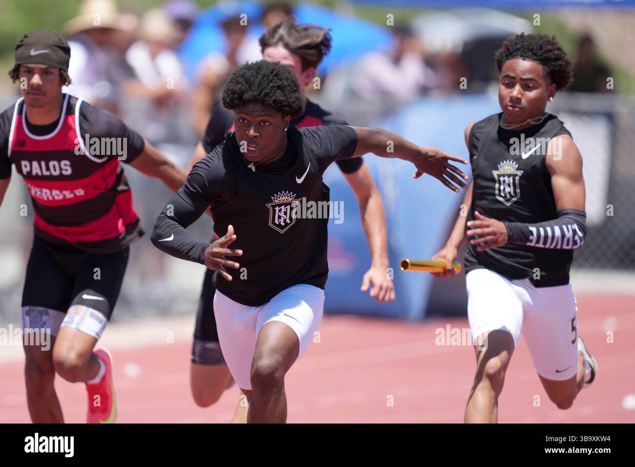 Benjamin Harris takes the handoff from Jorden Wills on the second leg ...