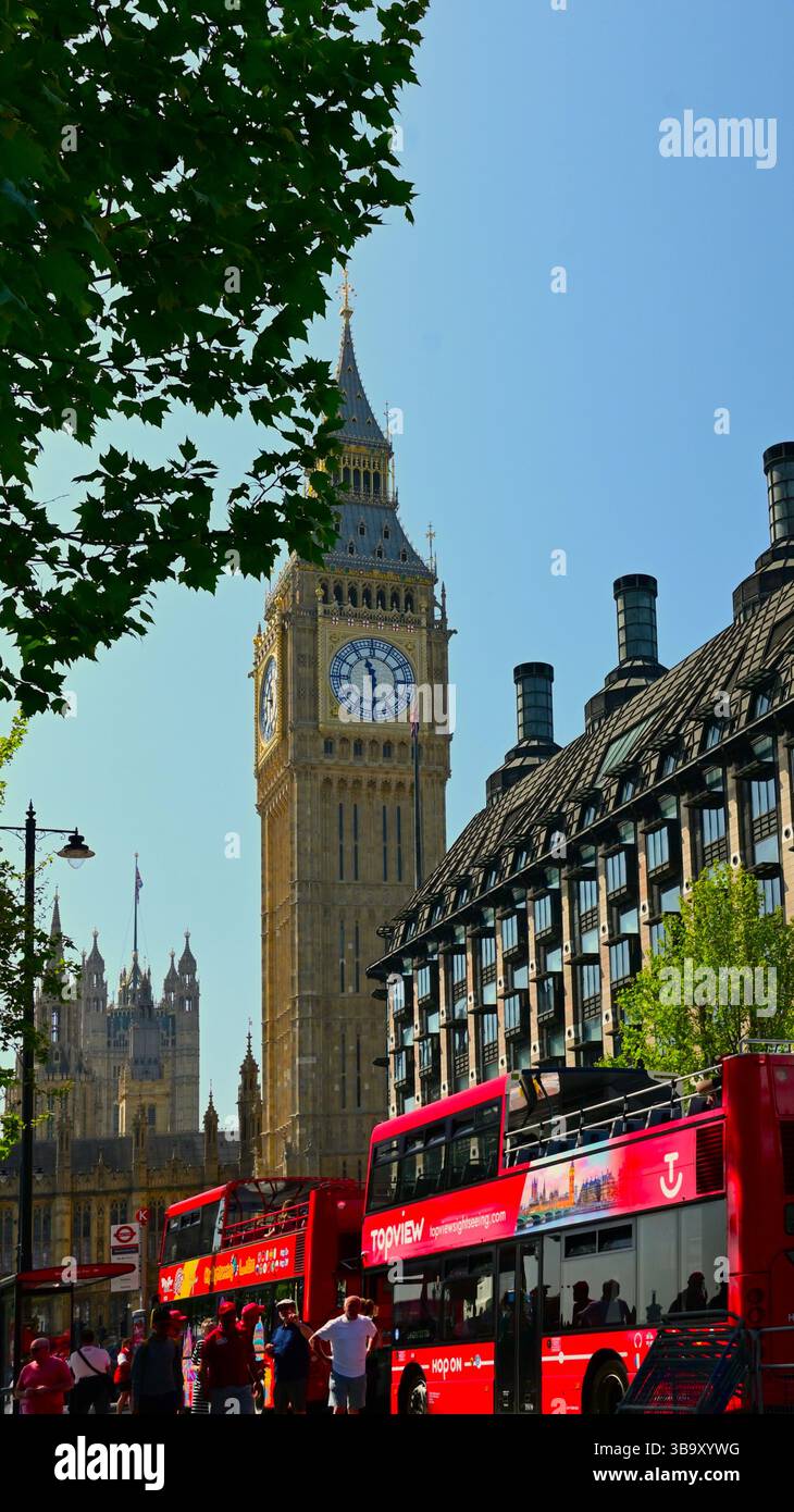 Big Ben from the Victoria Embankment (A3211) with red tour buses in ...