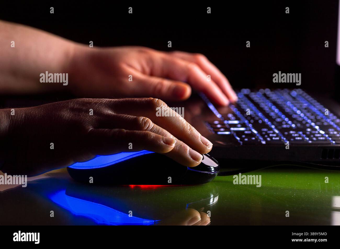 Close-up of hands gamer playing a multiplayer game on lan party at home ...
