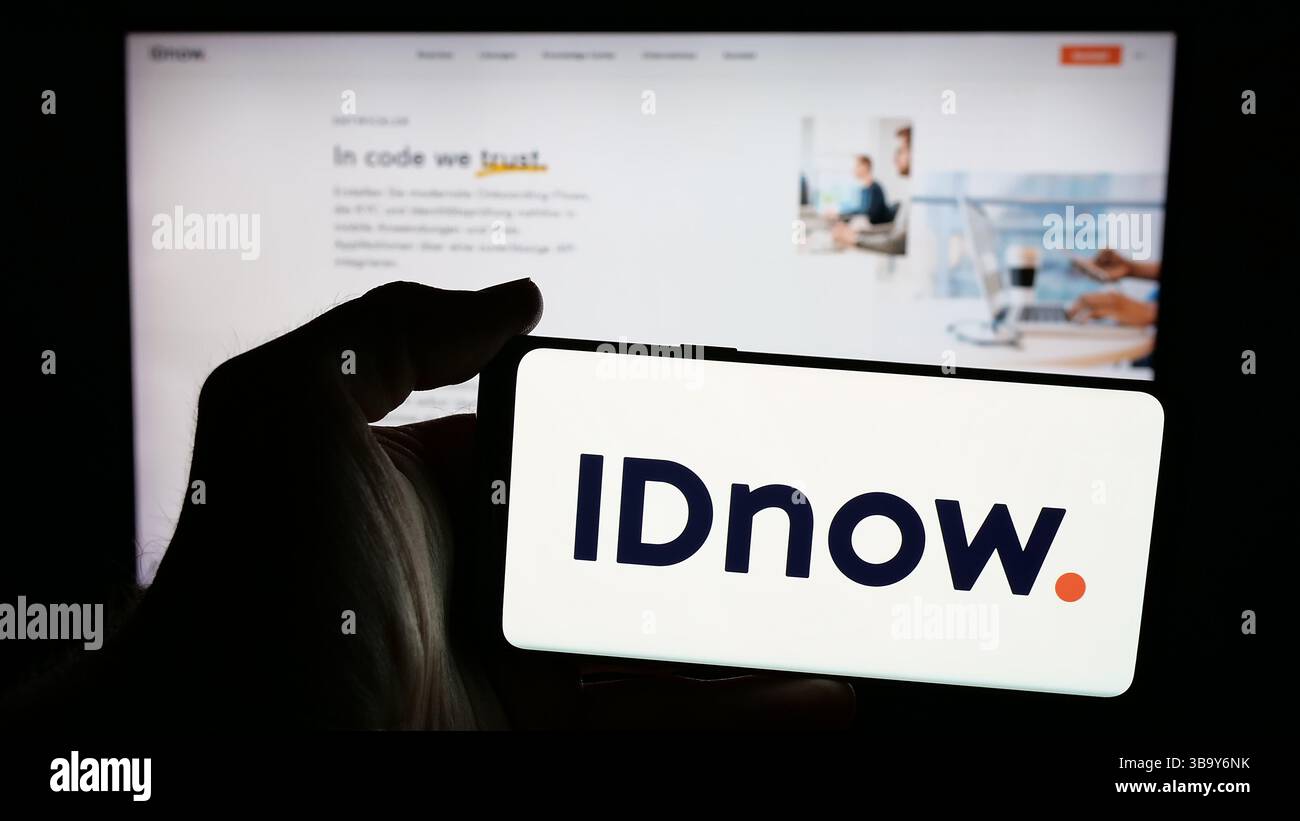 In this photo illustration, a person is holding a mobile phone with the ...