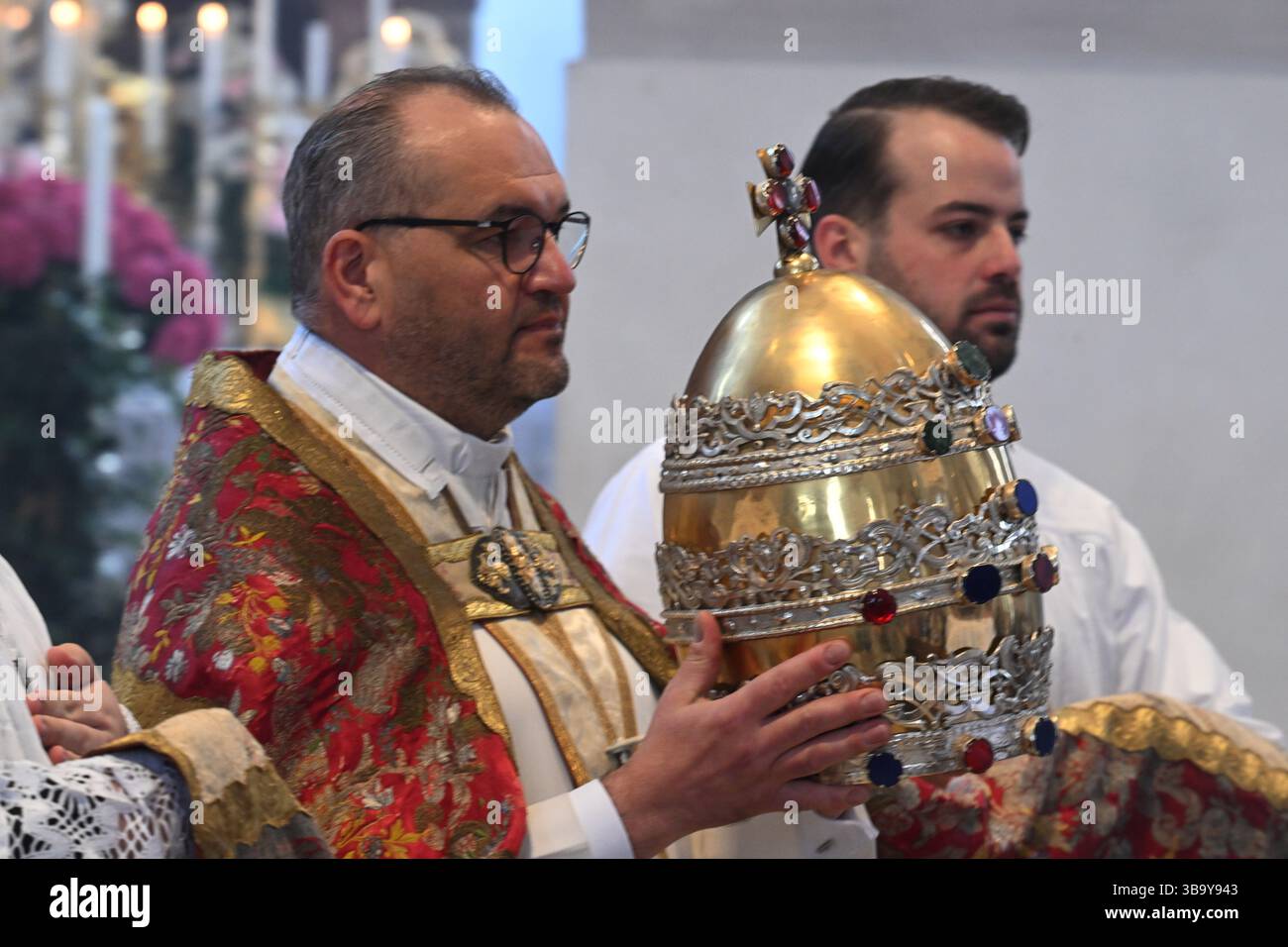 Munich, Germany. 11th May, 2025. Pastor Daniel Lerch carries the tiara ...