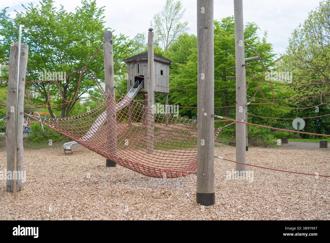 Childrens playground featuring wooden climbing structures, including a ...