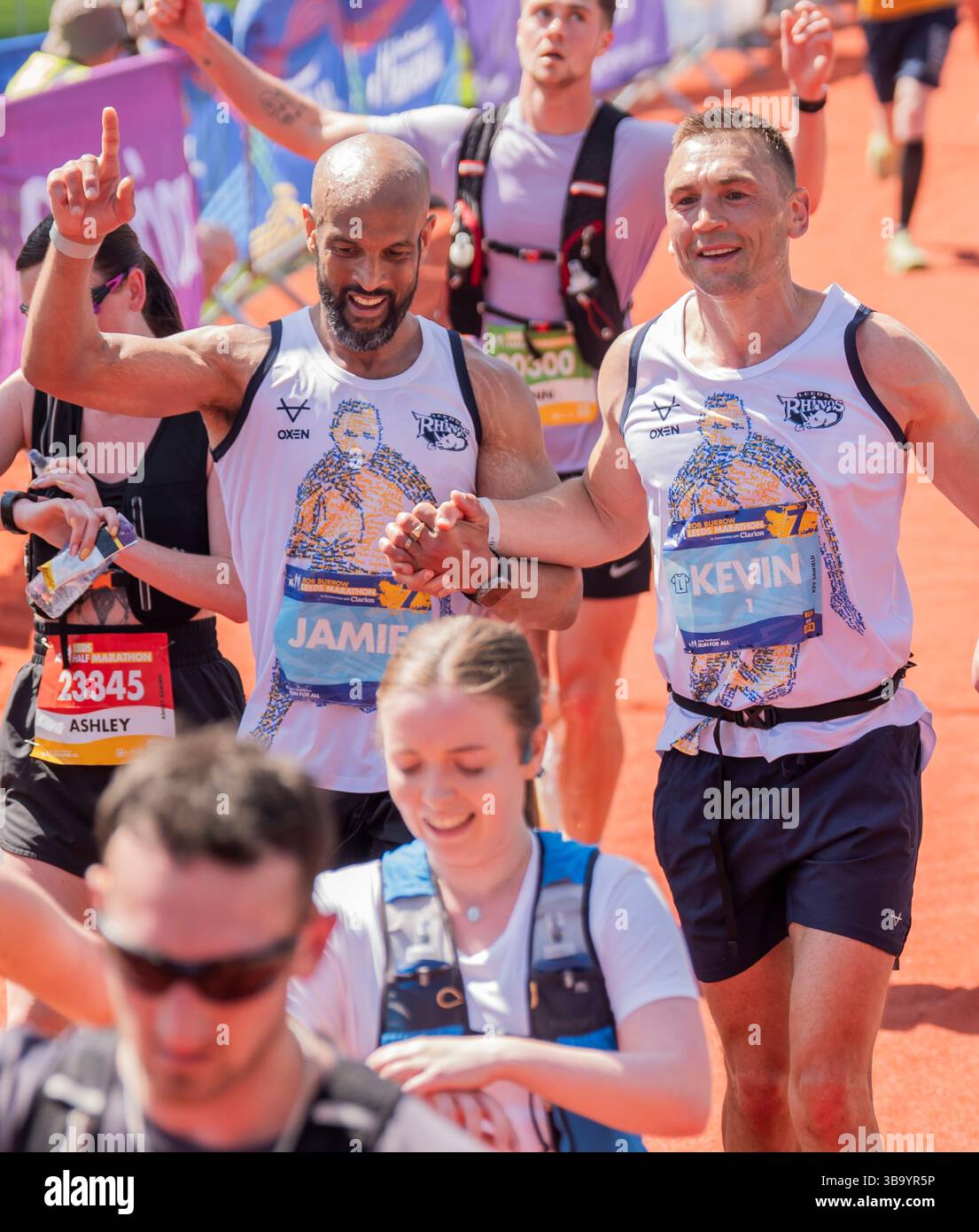 Kevin Sinfield (right) and Jamie Jones-Buchanan (left) cross the finish ...