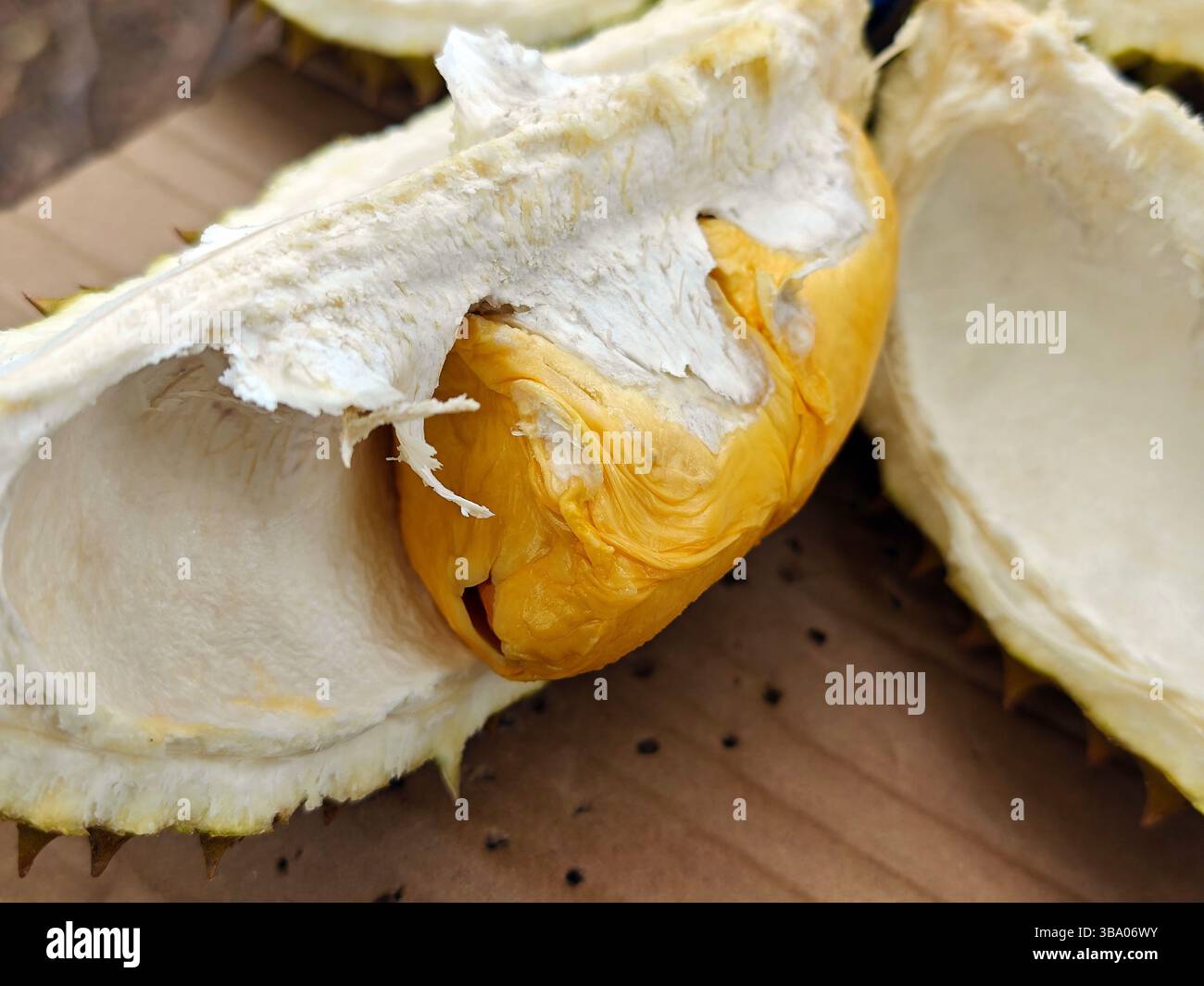 slice of fresh yellow durian pulp on the shell on the plate for eating ...
