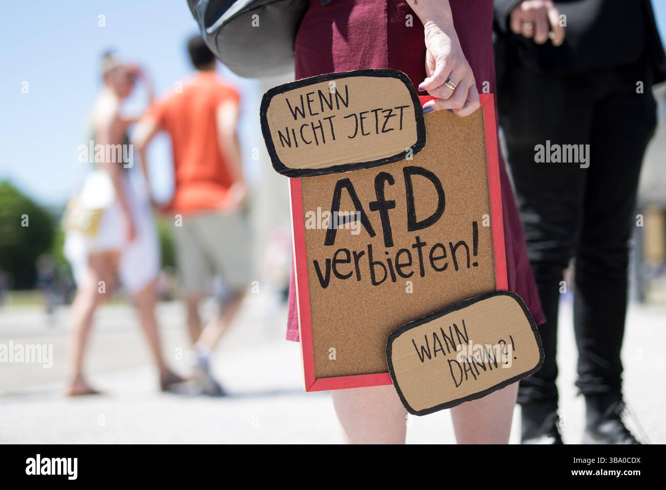 Munich, Germany. 11th May, 2025. A demonstrator holds a poster reading ...