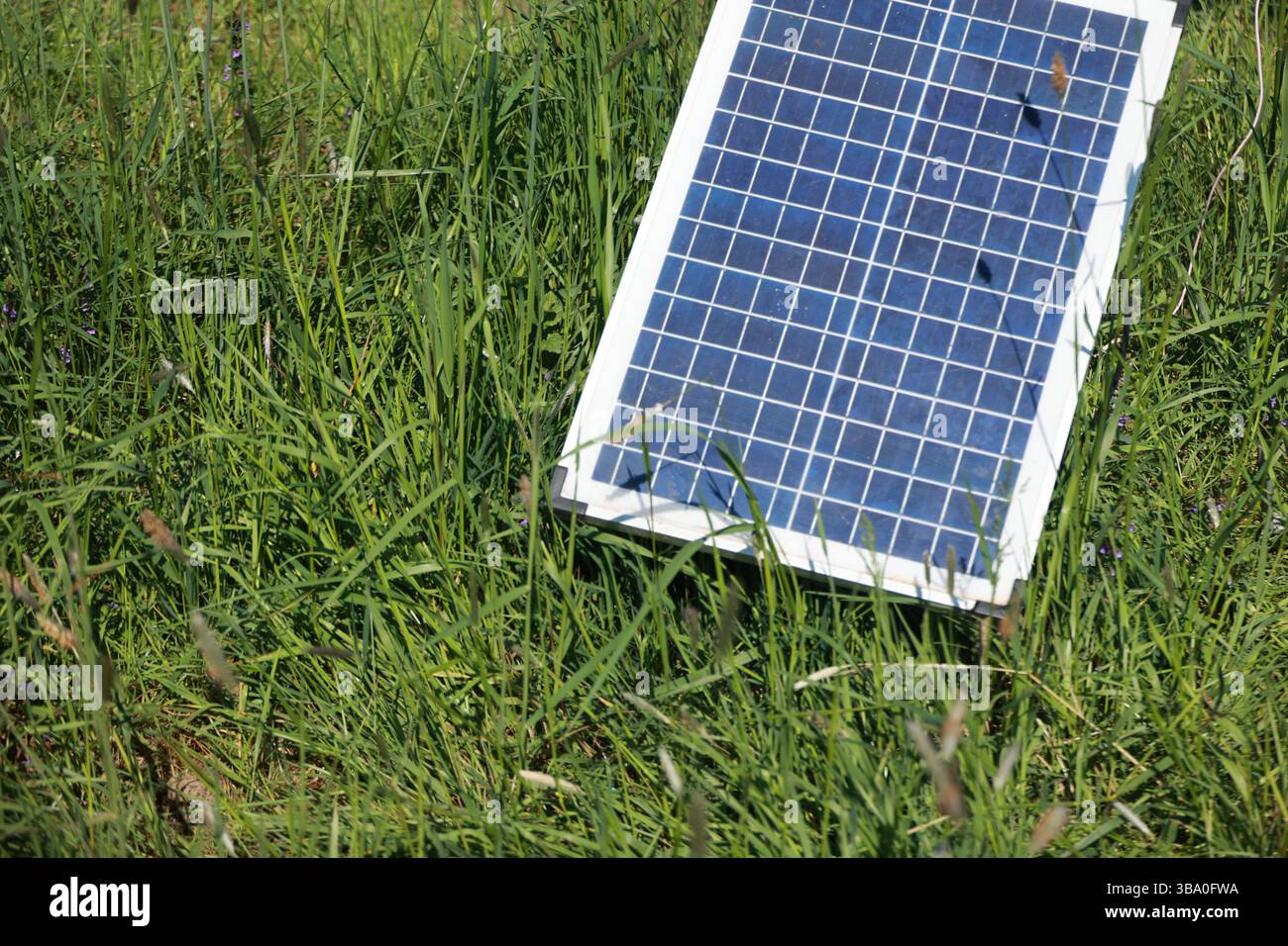 A solar panel is laying on the grass Stock Photo - Alamy