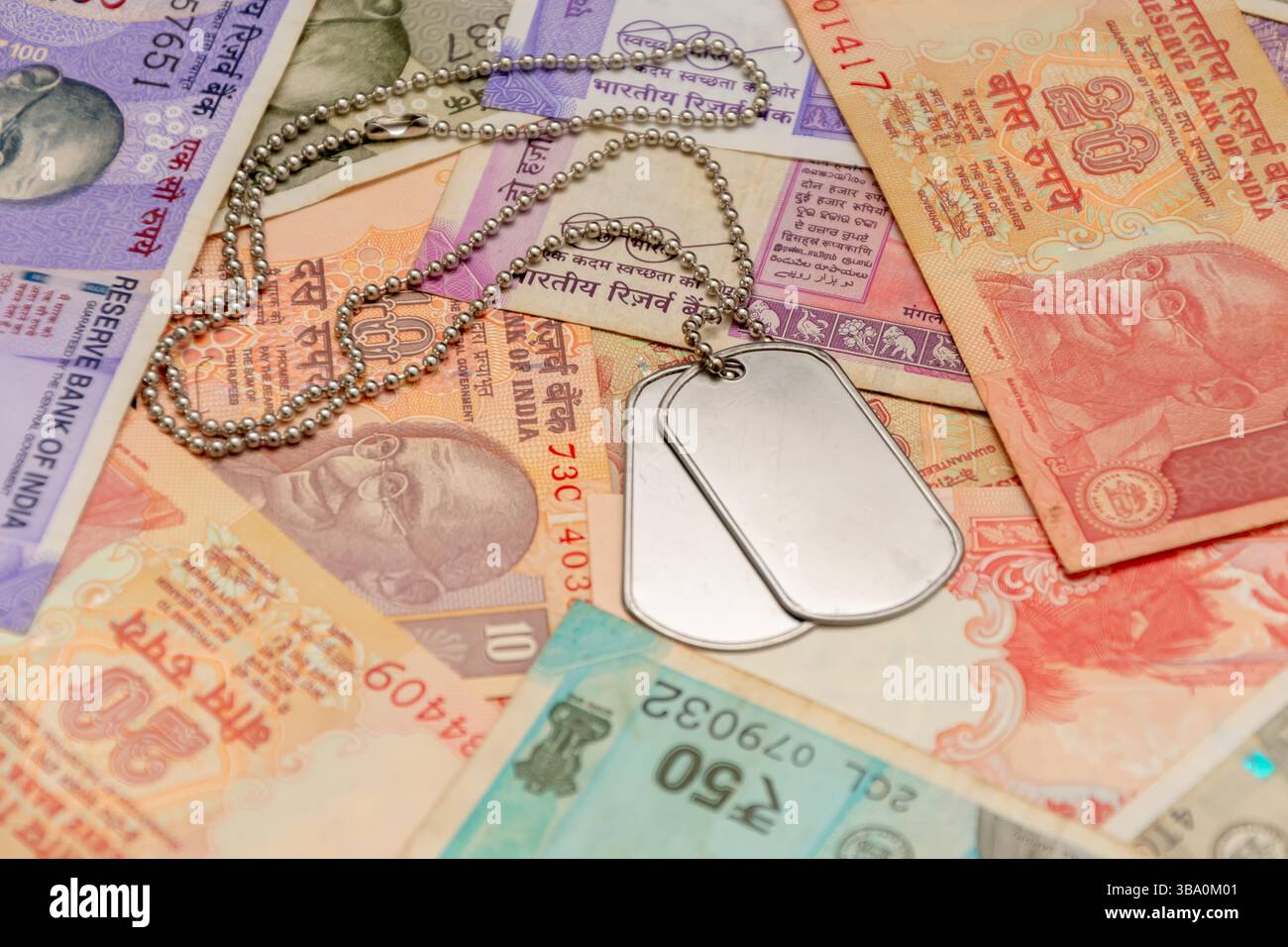 Military tokens in the background of Indian banknotes. A symbol of ...