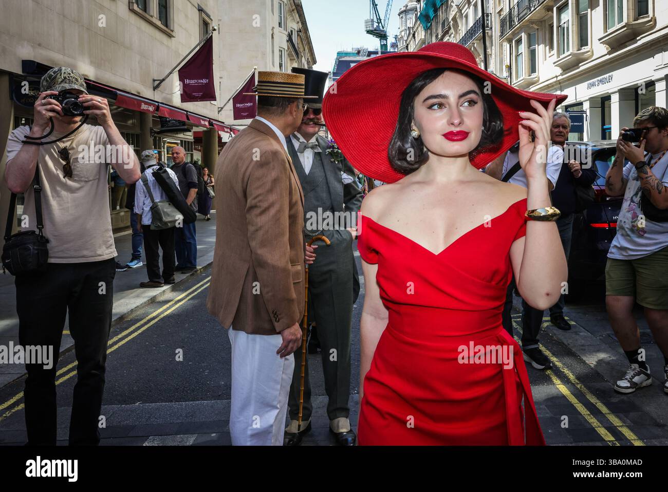 London, UK. 11th May, 2025. A lady in red draws attention in a striking ...