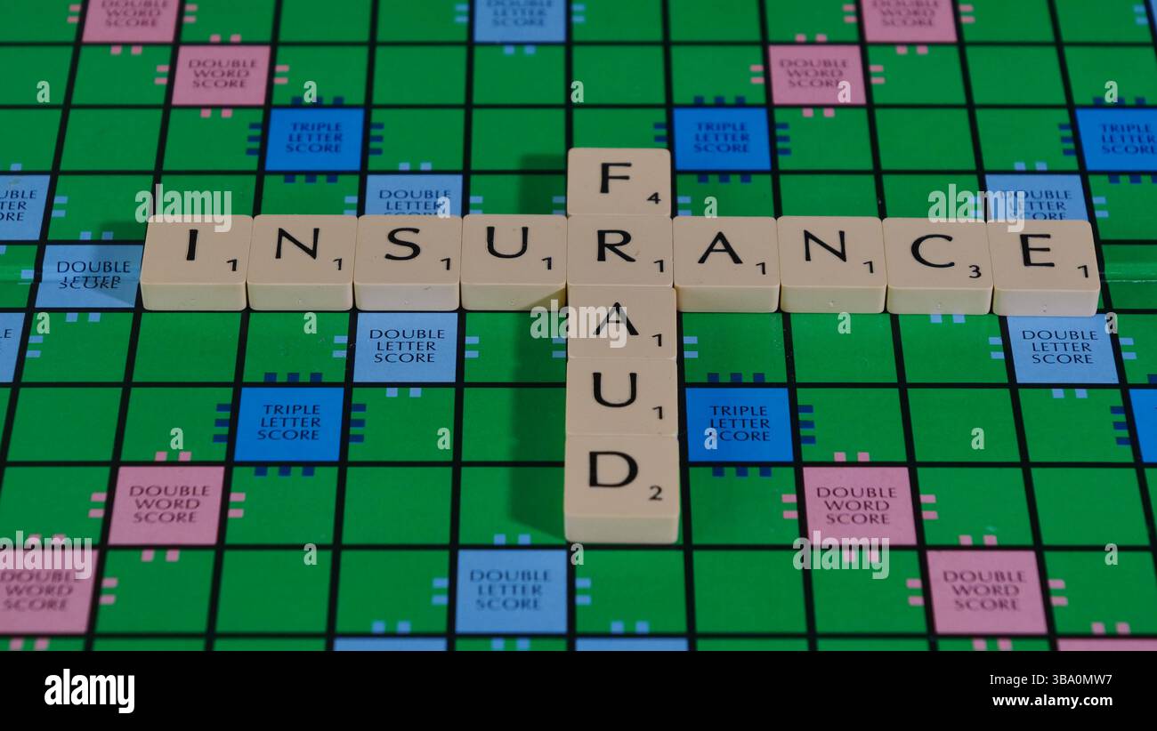 The concept of insruance fraud spelt out on a Scrabble board Stock ...