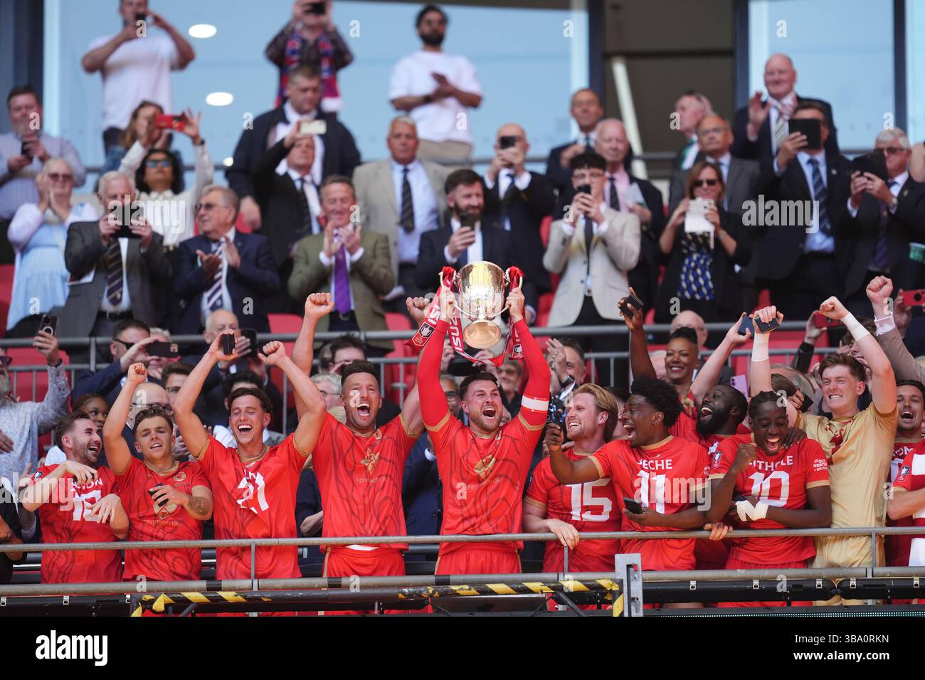 Whitstable Town's Captain Jake McIntyre lifts the trophy during the ...