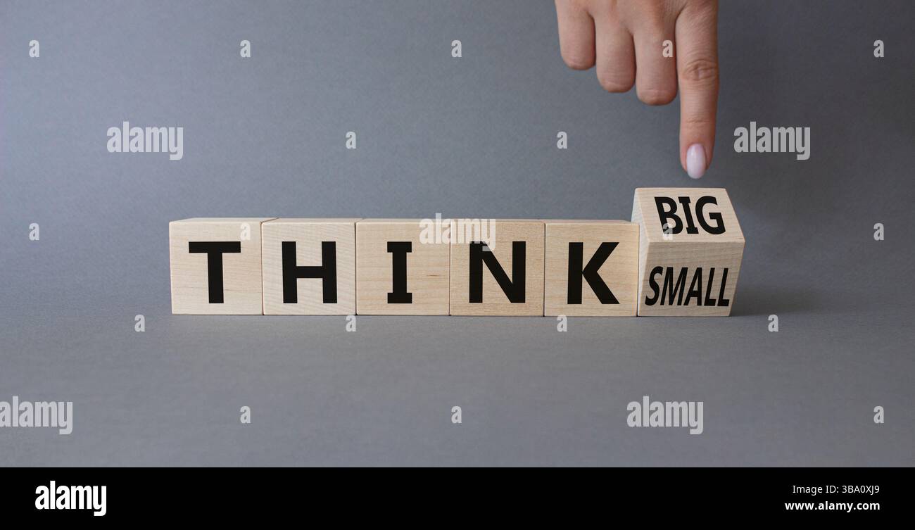 Think Big vs Small symbol. Businessman Hand points at wooden cubes with ...