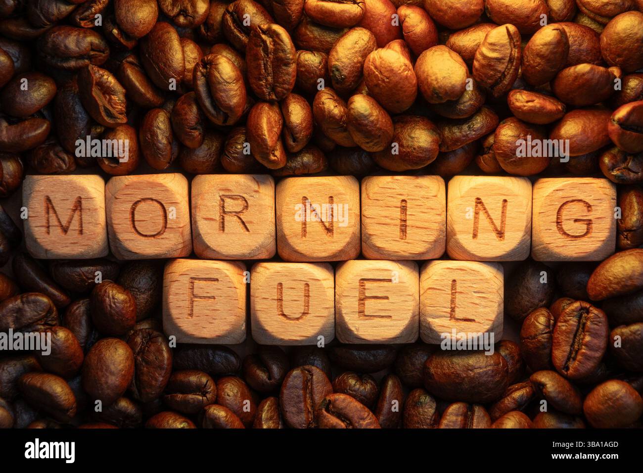 Morning fuel: wooden blocks surrounded by coffee beans Stock Photo - Alamy