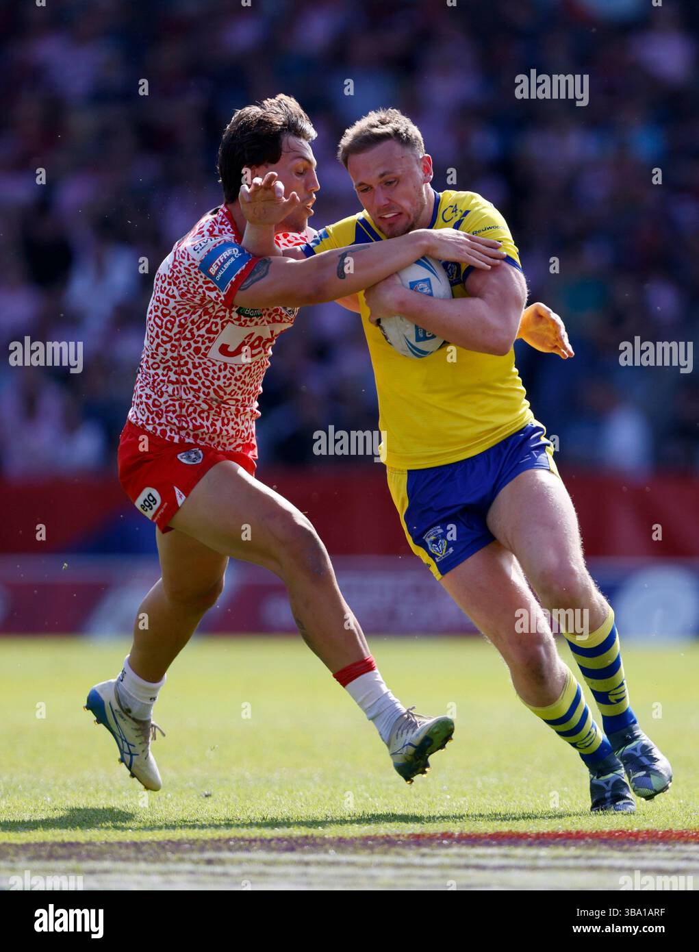 Warrington Ben Currie is tackled during the Betfred Challenge Cup semi ...