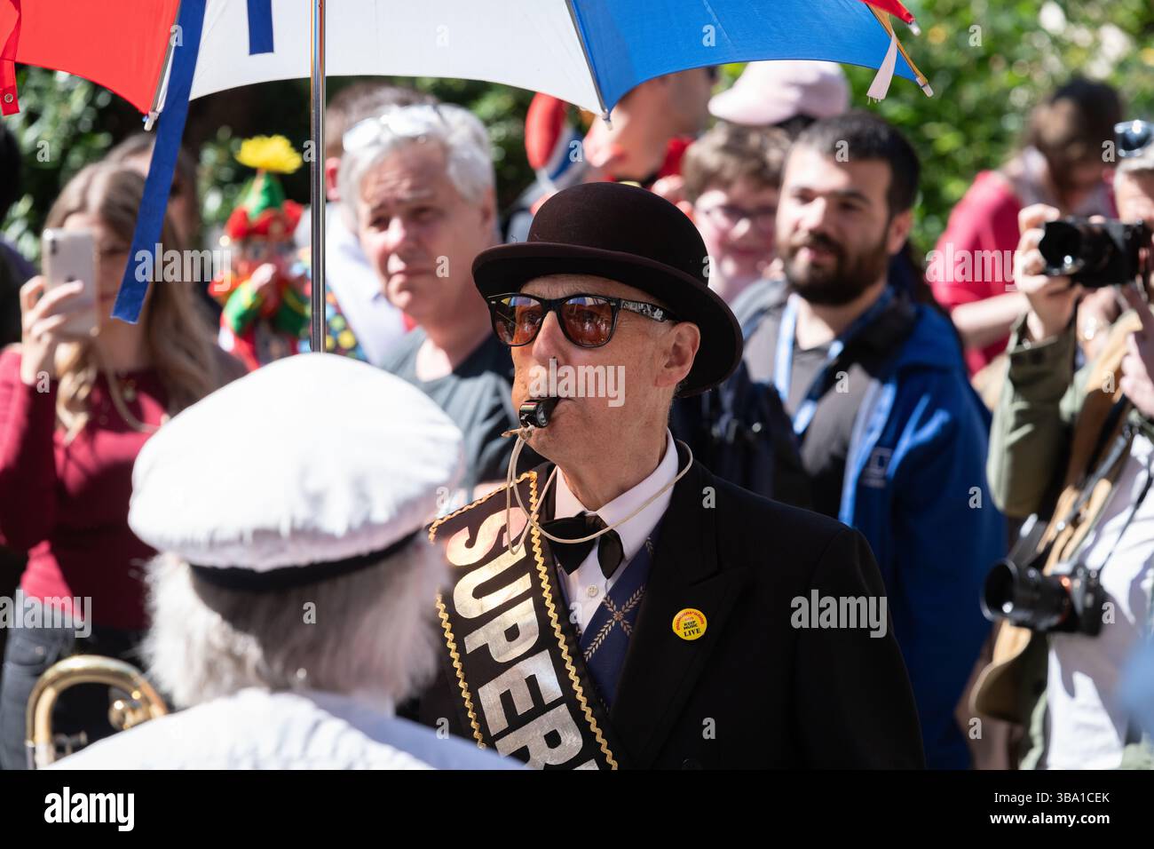 London, UK. 11 May, 2025. The leader of the Superior Brass Band at the ...